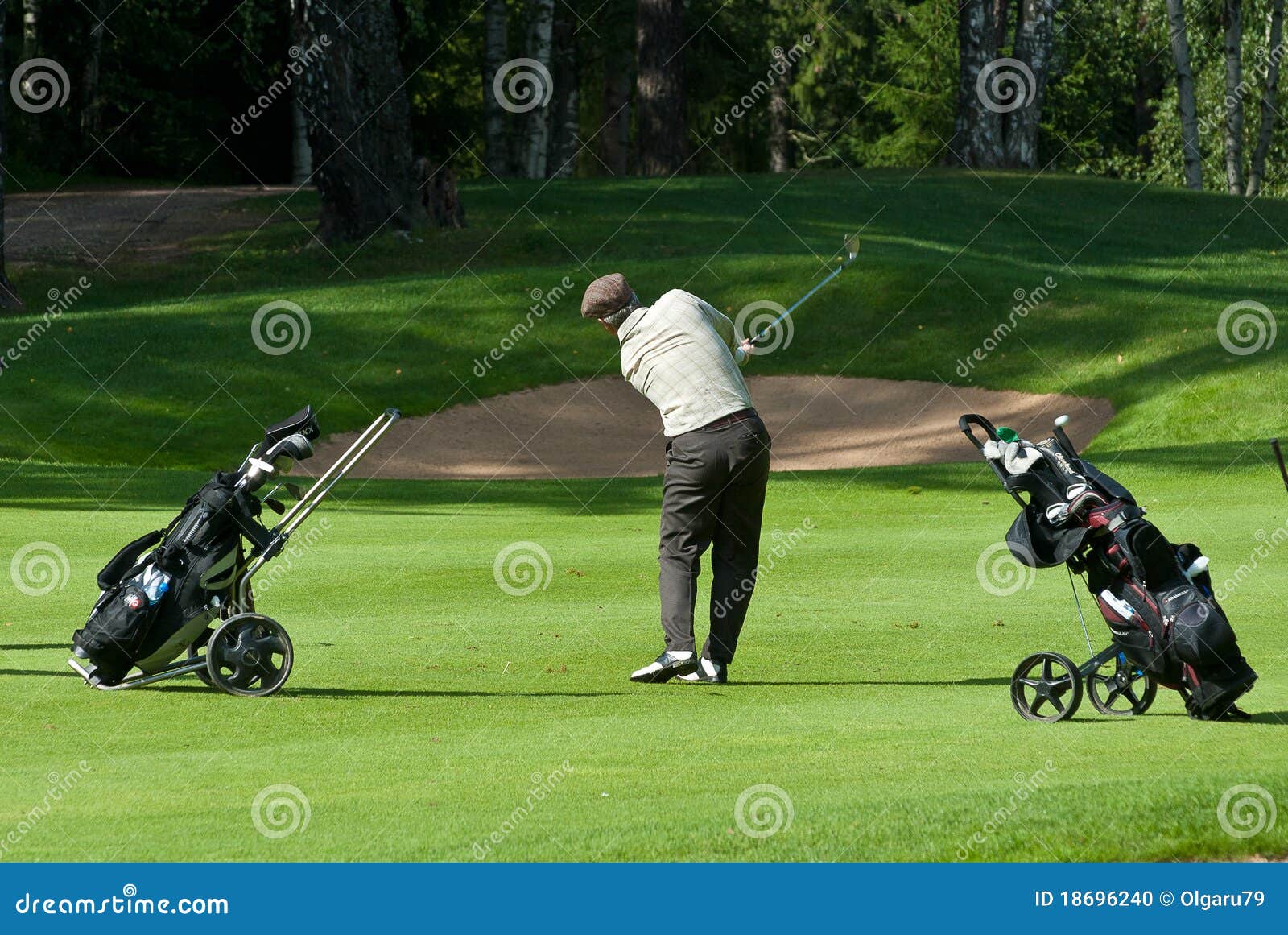 Golfer finishes his swing editorial image. Image of boomers - 18696240