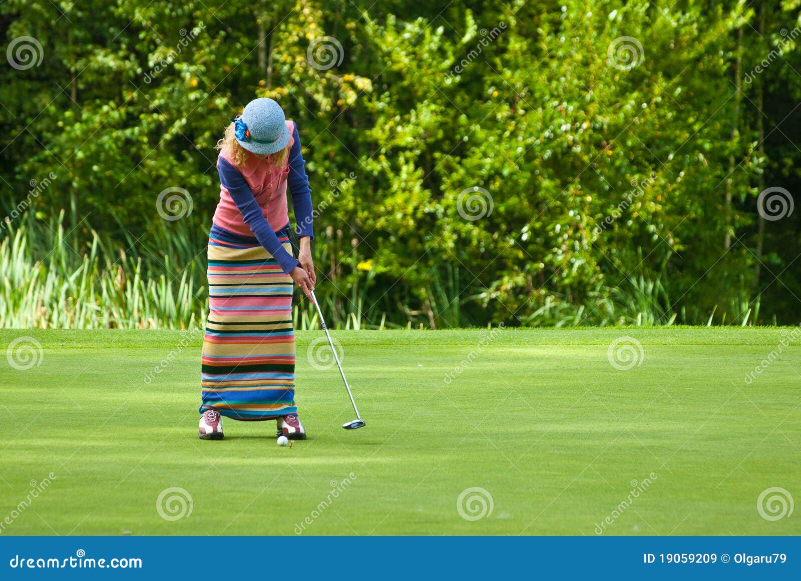 Golfer finishes his swing editorial stock image. Image of link - 19059209