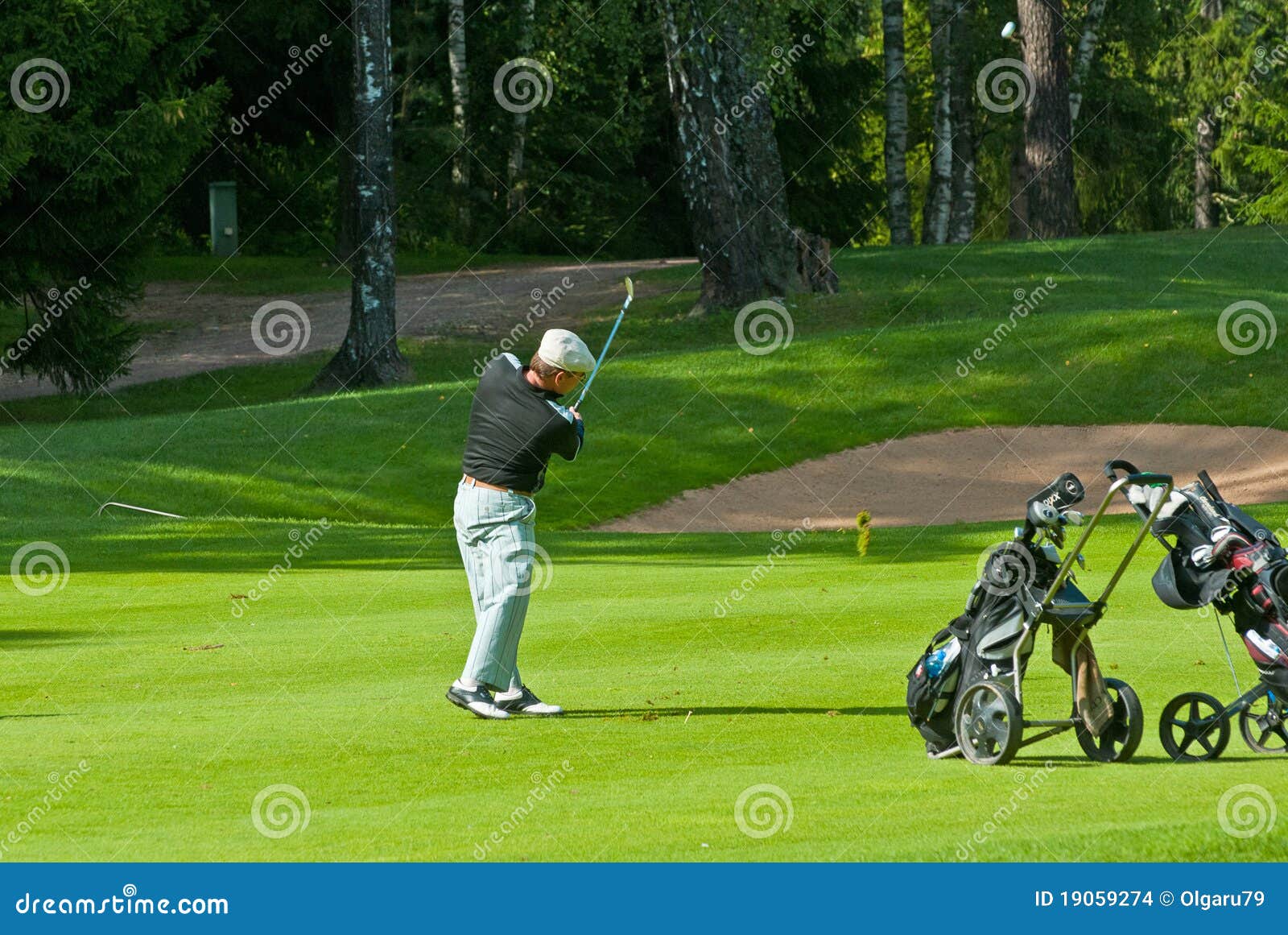 Golfer finishes his swing editorial stock image. Image of beautiful ...