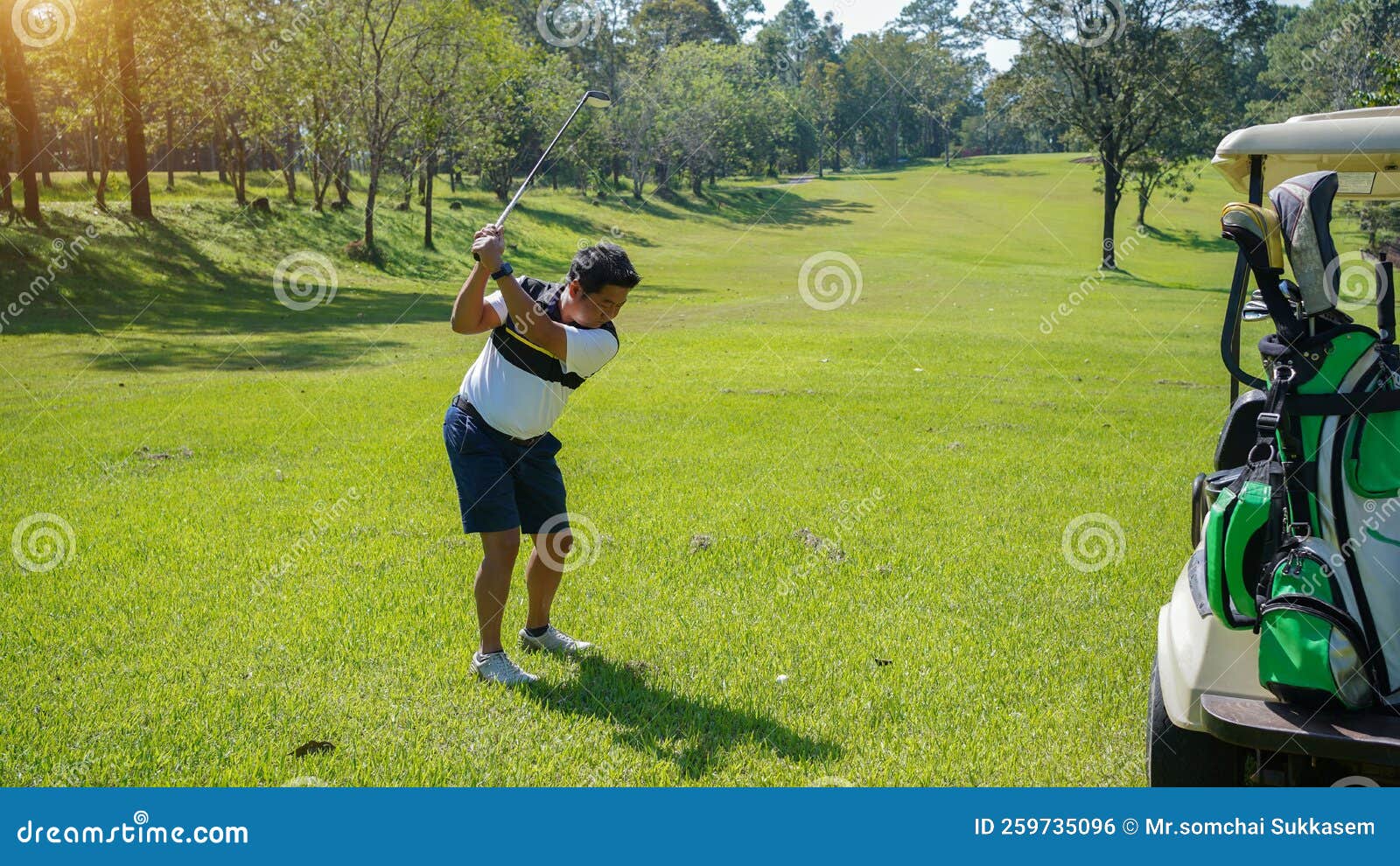 Golfer Playing Golf in the Evening Golf Course, on Sun Set Evening Time ...