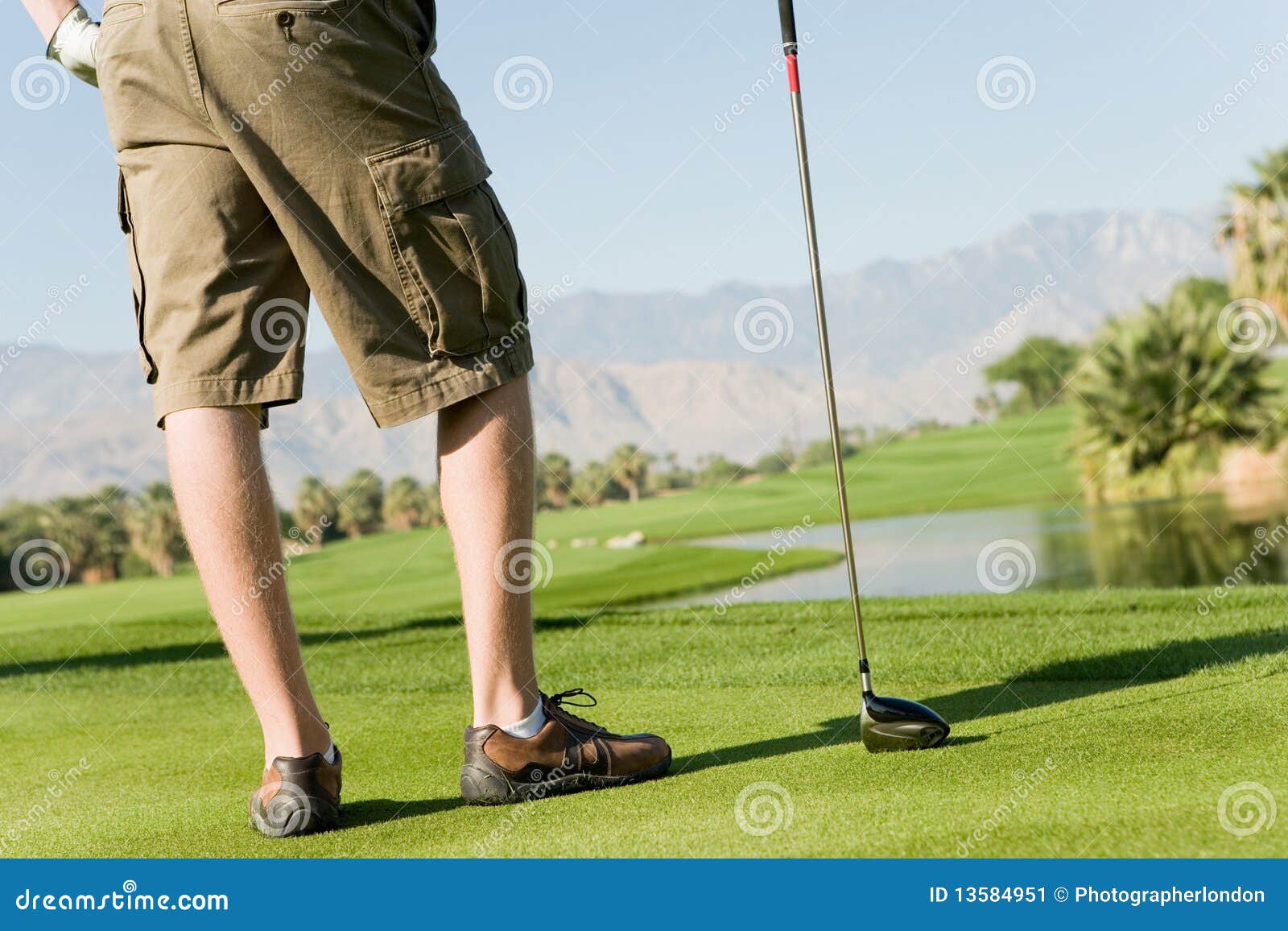 Golfer Standing on Golf Course Holding Club Stock Image - Image of ...
