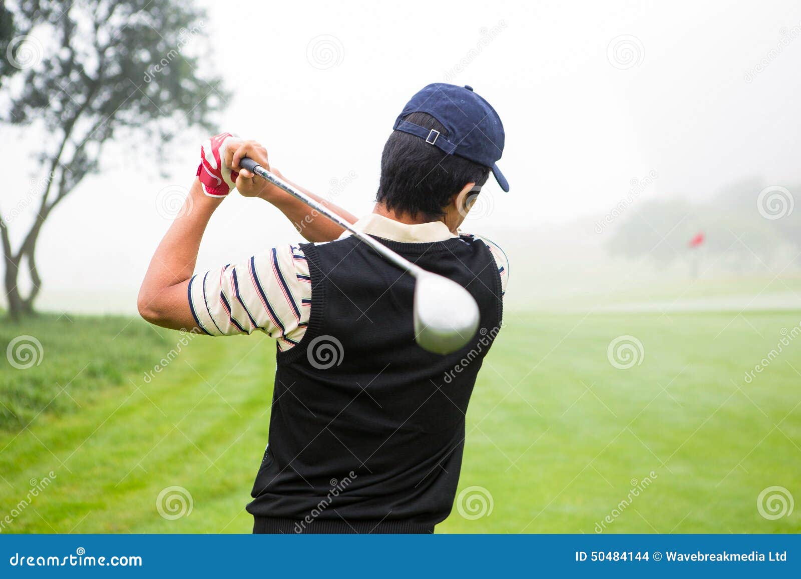 Golfer teeing off stock photo. Image of focused, activities - 50484144