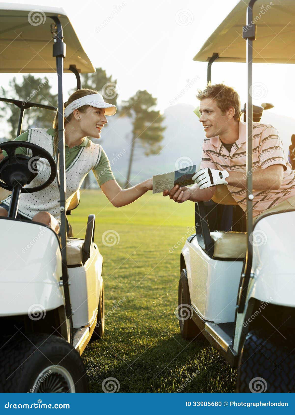 Golfers Sitting in Golf Carts Holding Score Card Stock Photo - Image of ...