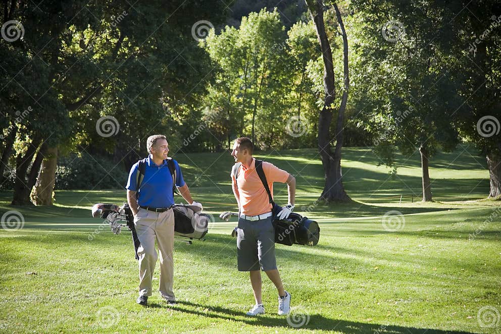 Golfers Talking on the Course Stock Photo - Image of morning, fairway ...