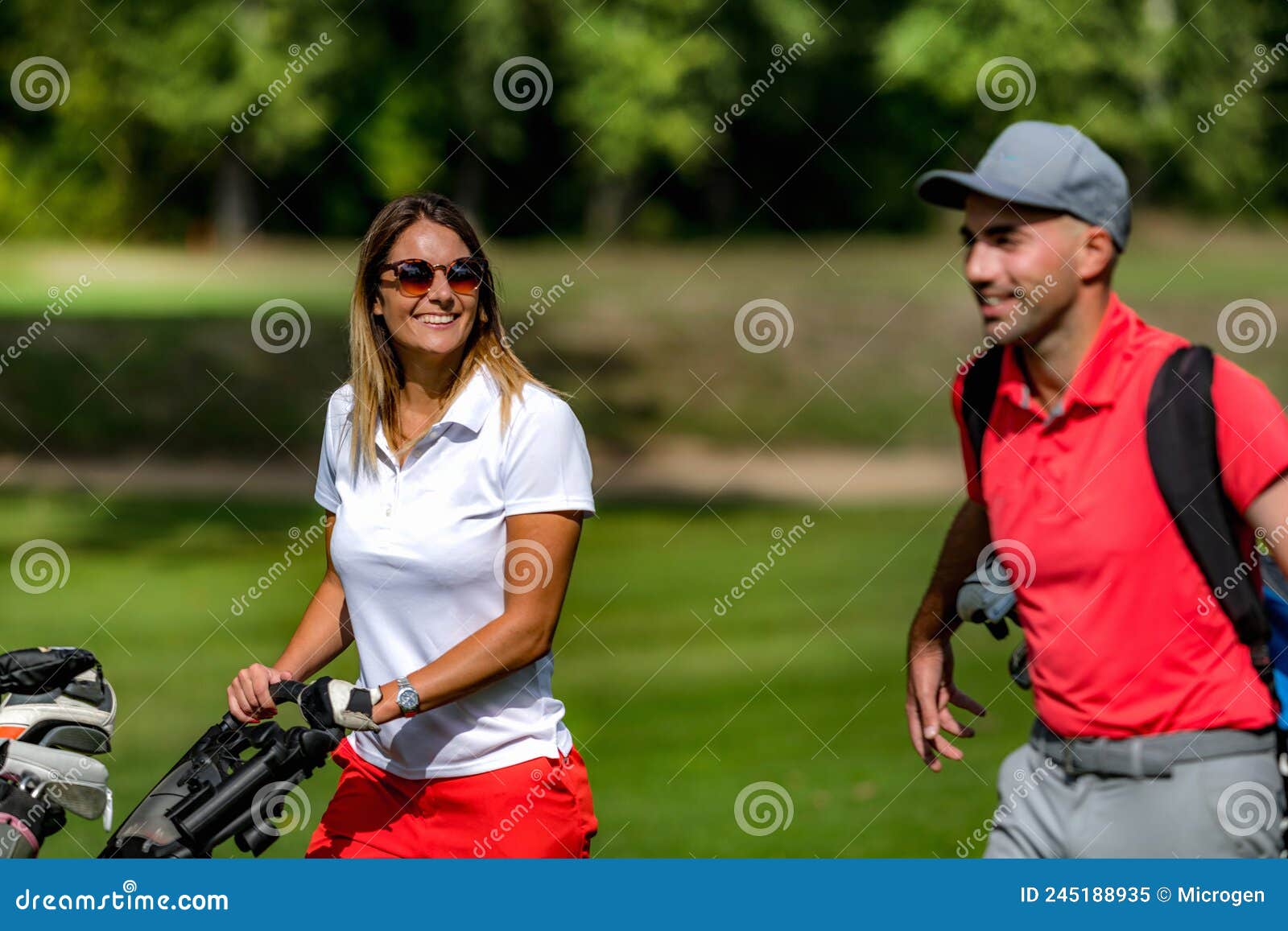 Golfing Couple Enjoying a Game on a Golf Course Stock Image - Image of ...