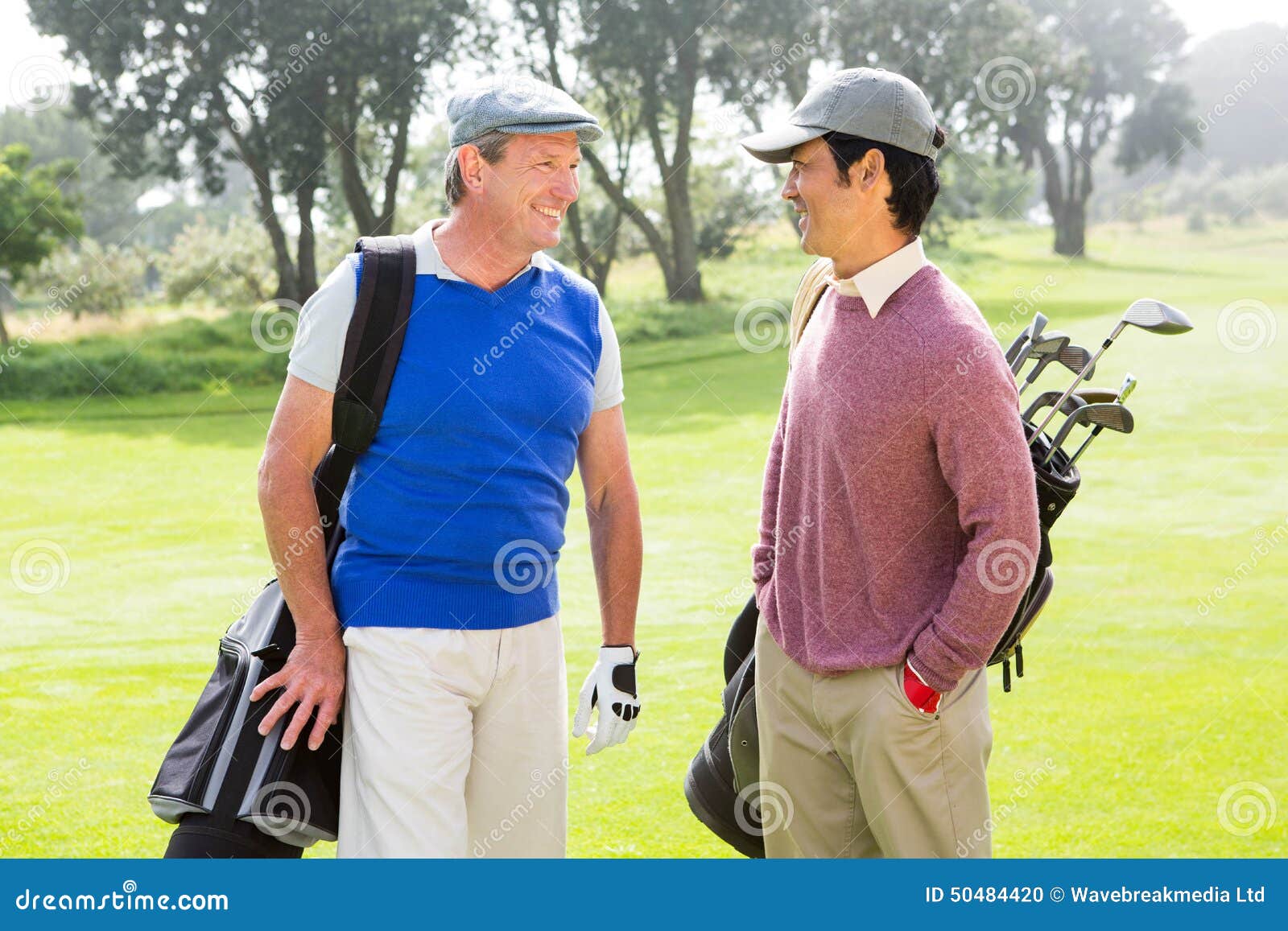Golfing Friends Smiling and Holding Clubs Stock Photo - Image of hands ...