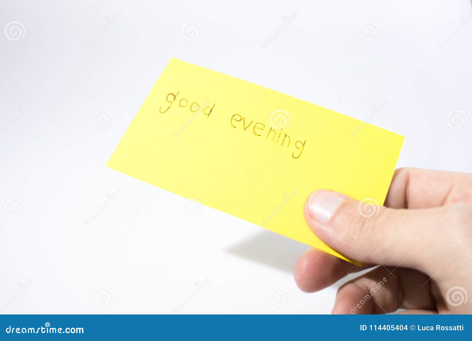 Good Evening Handwrite with a Hand on a Yellow Paper Stock Photo ...