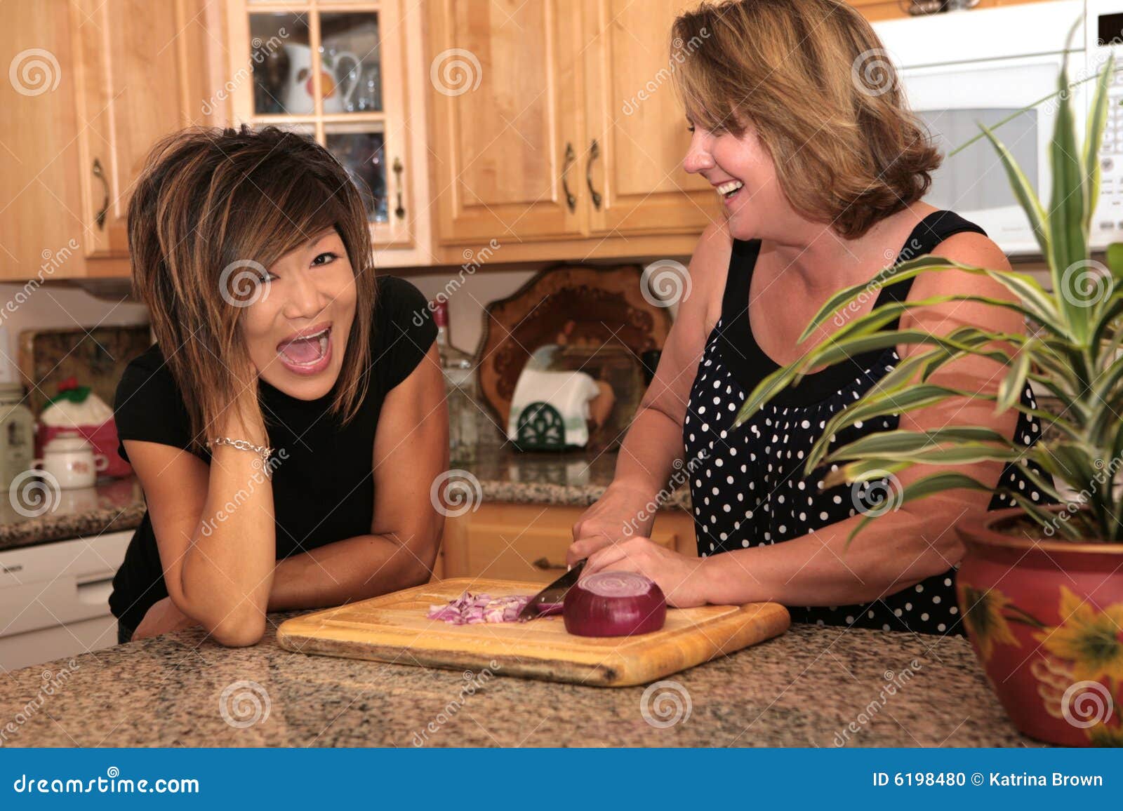 Good Gossip in the Kitchen stock photo. Image of asian - 6198480