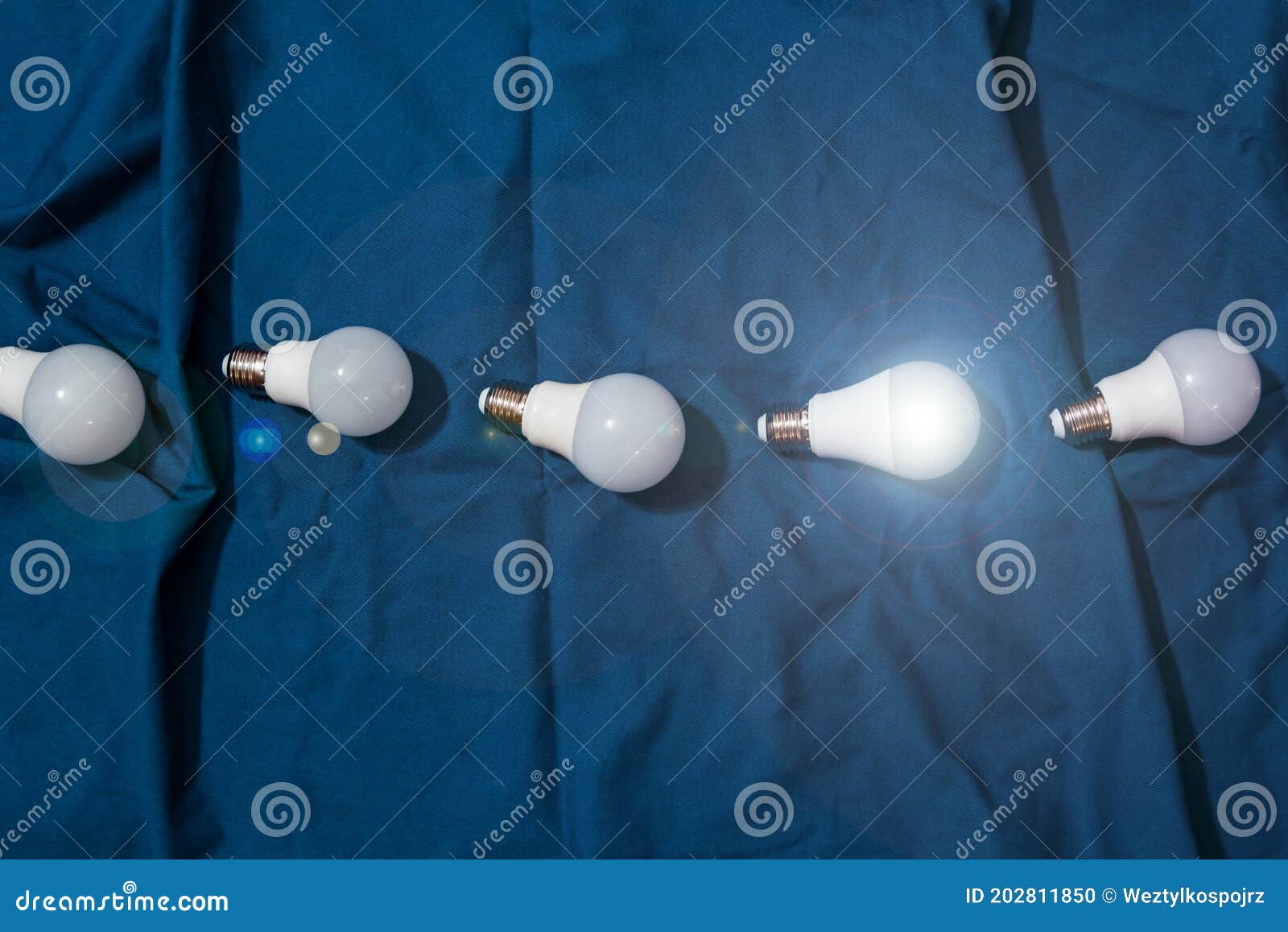 Good Idea Light Bulbs on Blue Fabric Stock Photo - Image of sphere ...