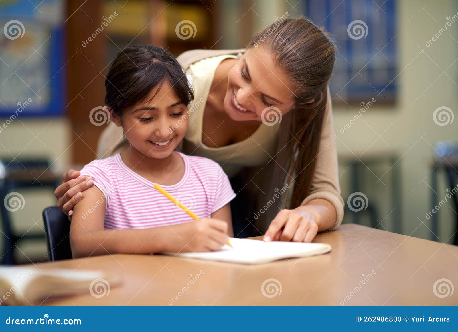 Good Job. a Teacher Helping Her Student with Her Work in the Classroom ...