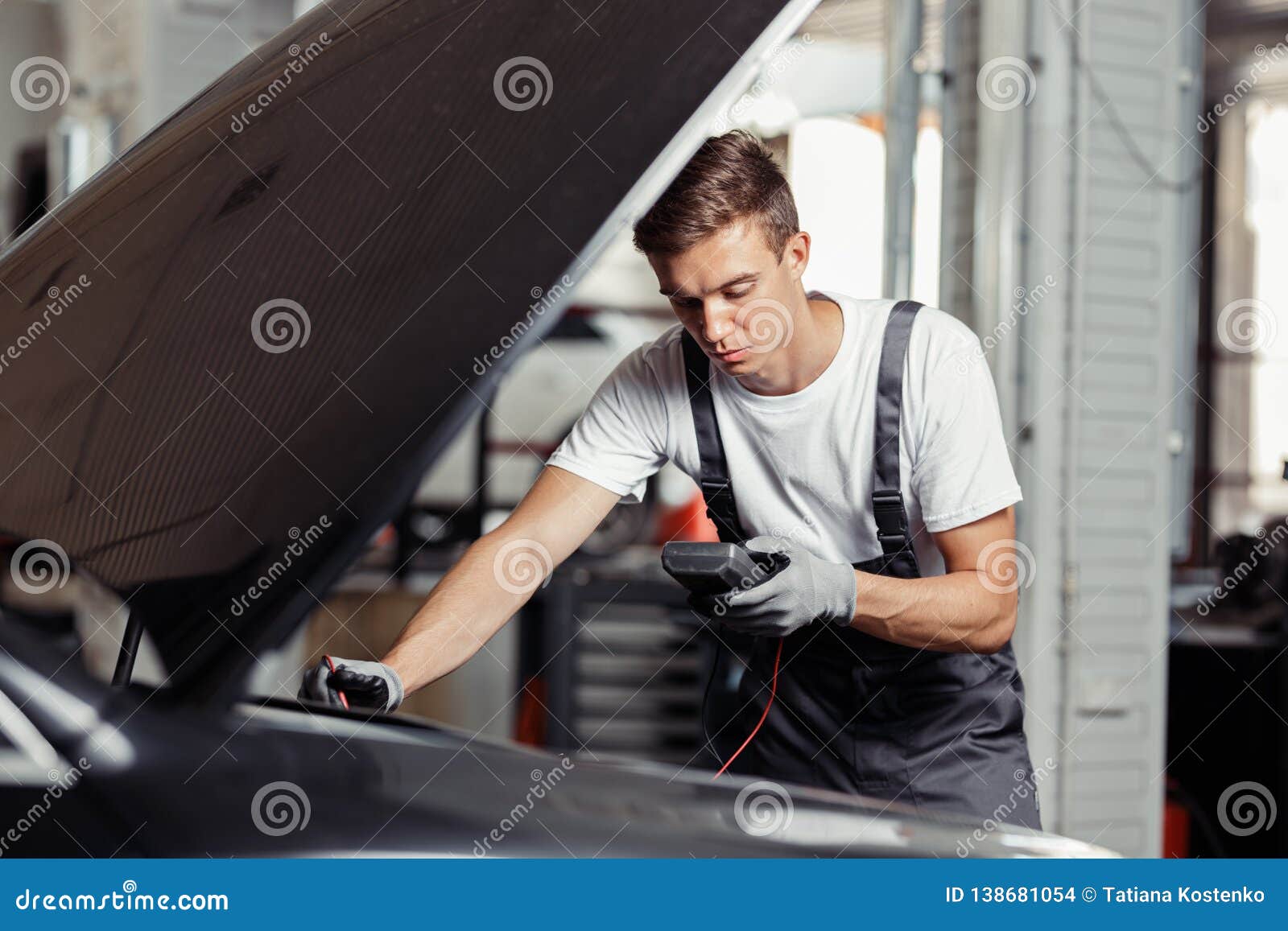 A Good-looking Blond Mechanic in Uniform is Checking Indicators of a ...