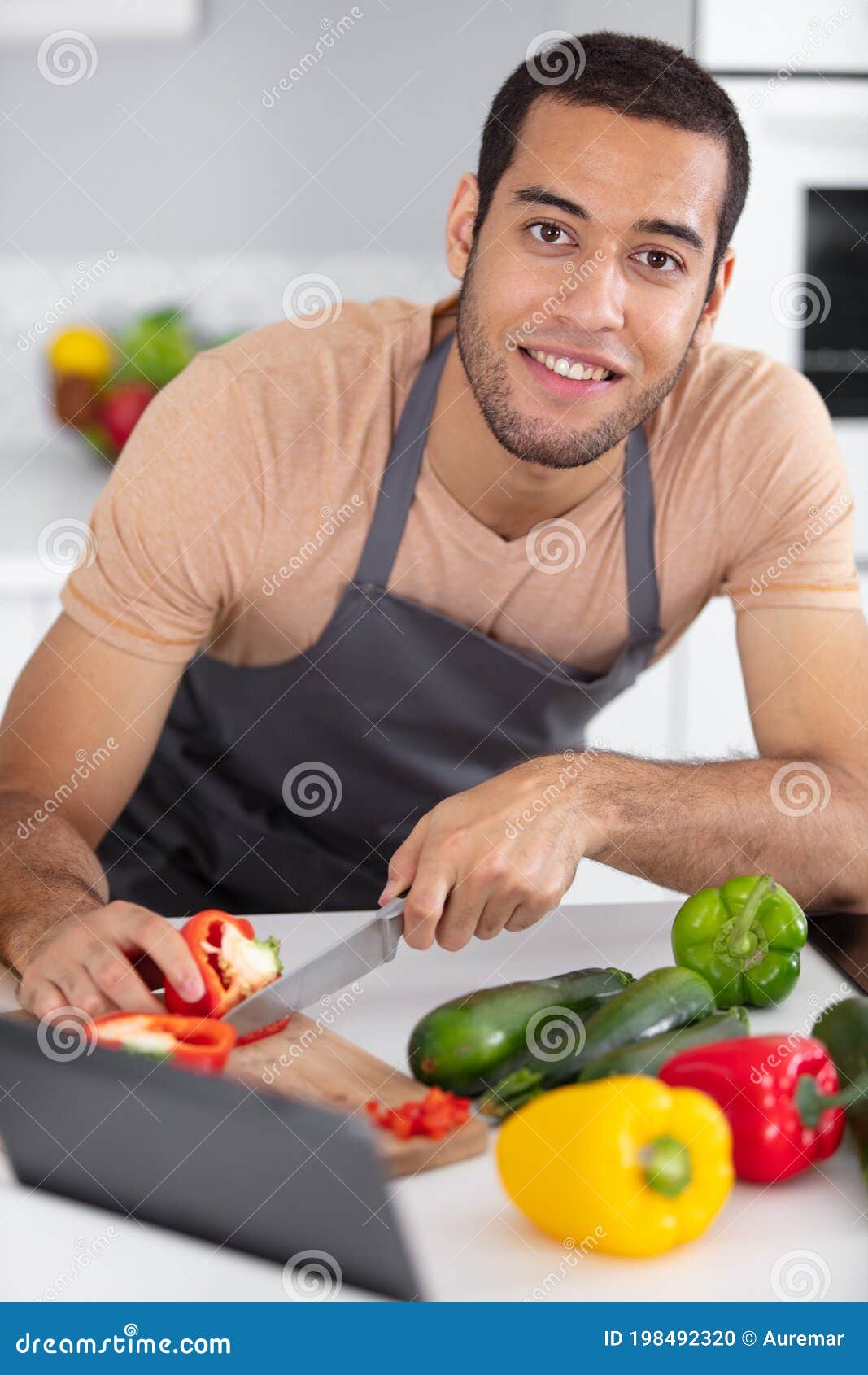 Good Looking Man in Apron Cutting Vegetables Stock Photo - Image of ...