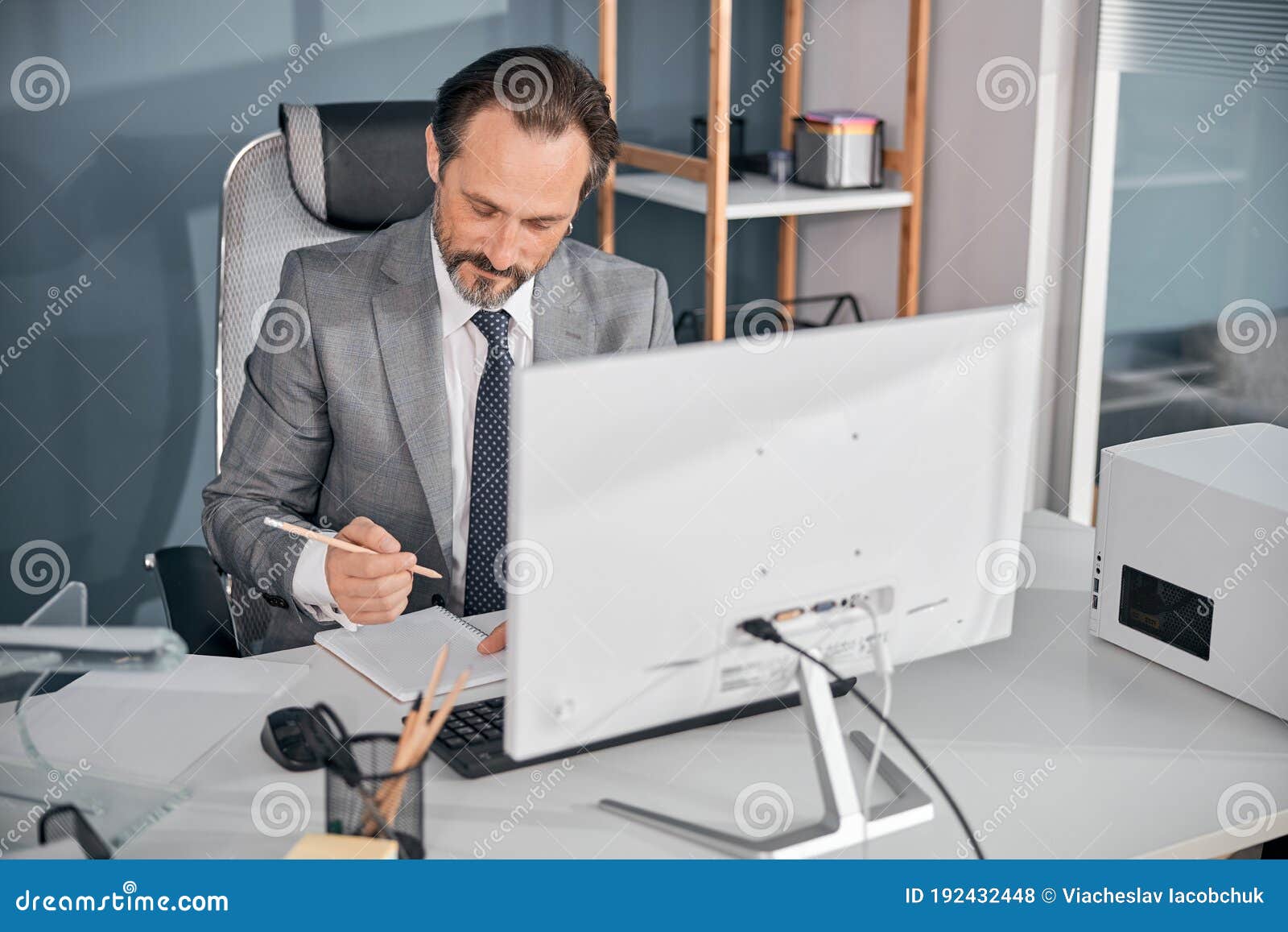Good-looking Man Writing in Notebook at Work Stock Photo - Image of ...