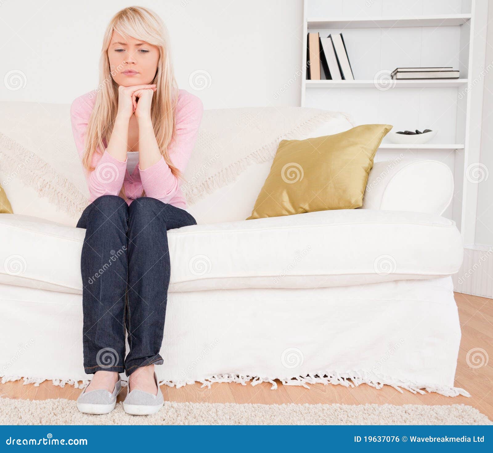 Good Looking Pensive Female Sitting on a Sofa Stock Photo - Image of ...
