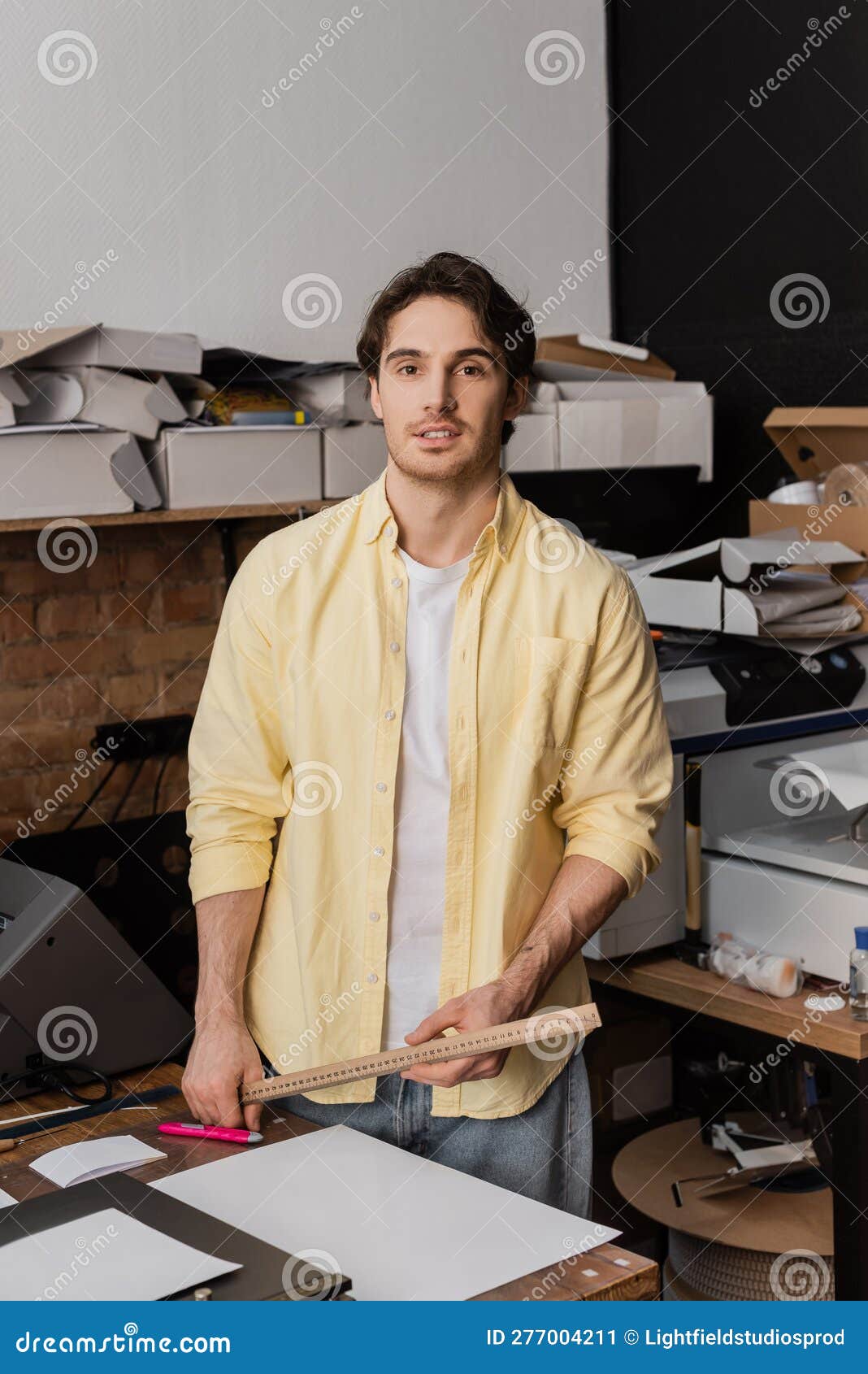Good Looking Printing Operator Holding Ruler Stock Image - Image of ...