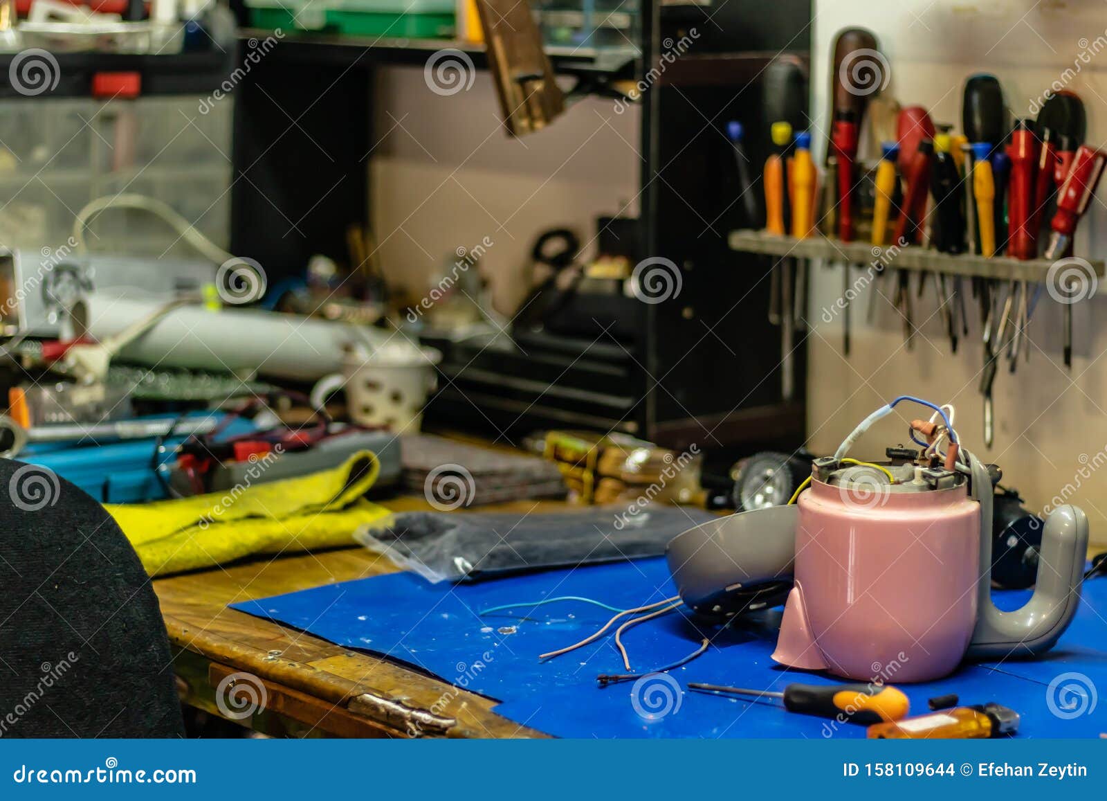 A Good Looking Tinker Table with Many Tools and Compenents on it Stock ...