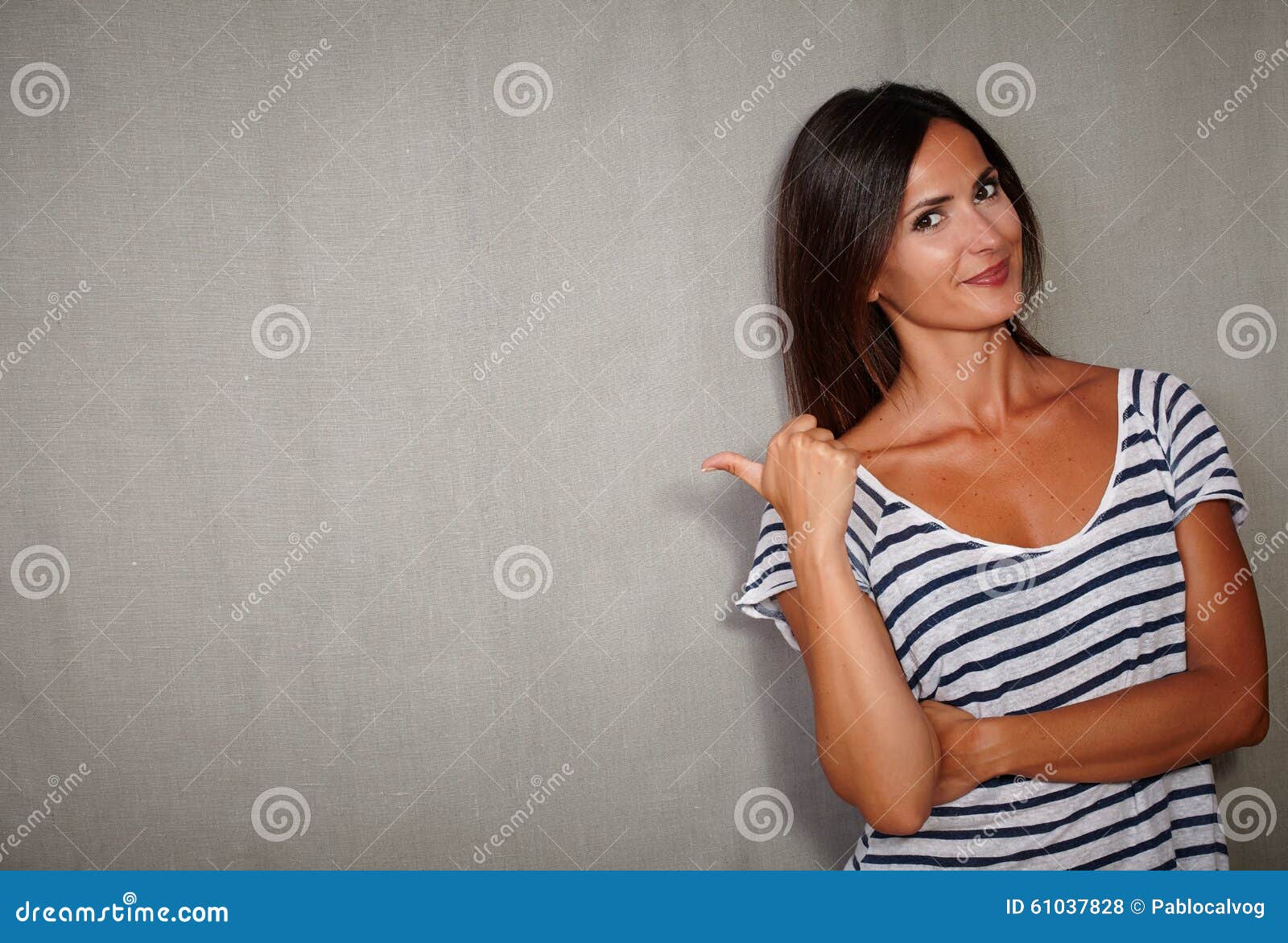 Good-looking Woman Pointing while Smiling at Camera Stock Photo - Image ...