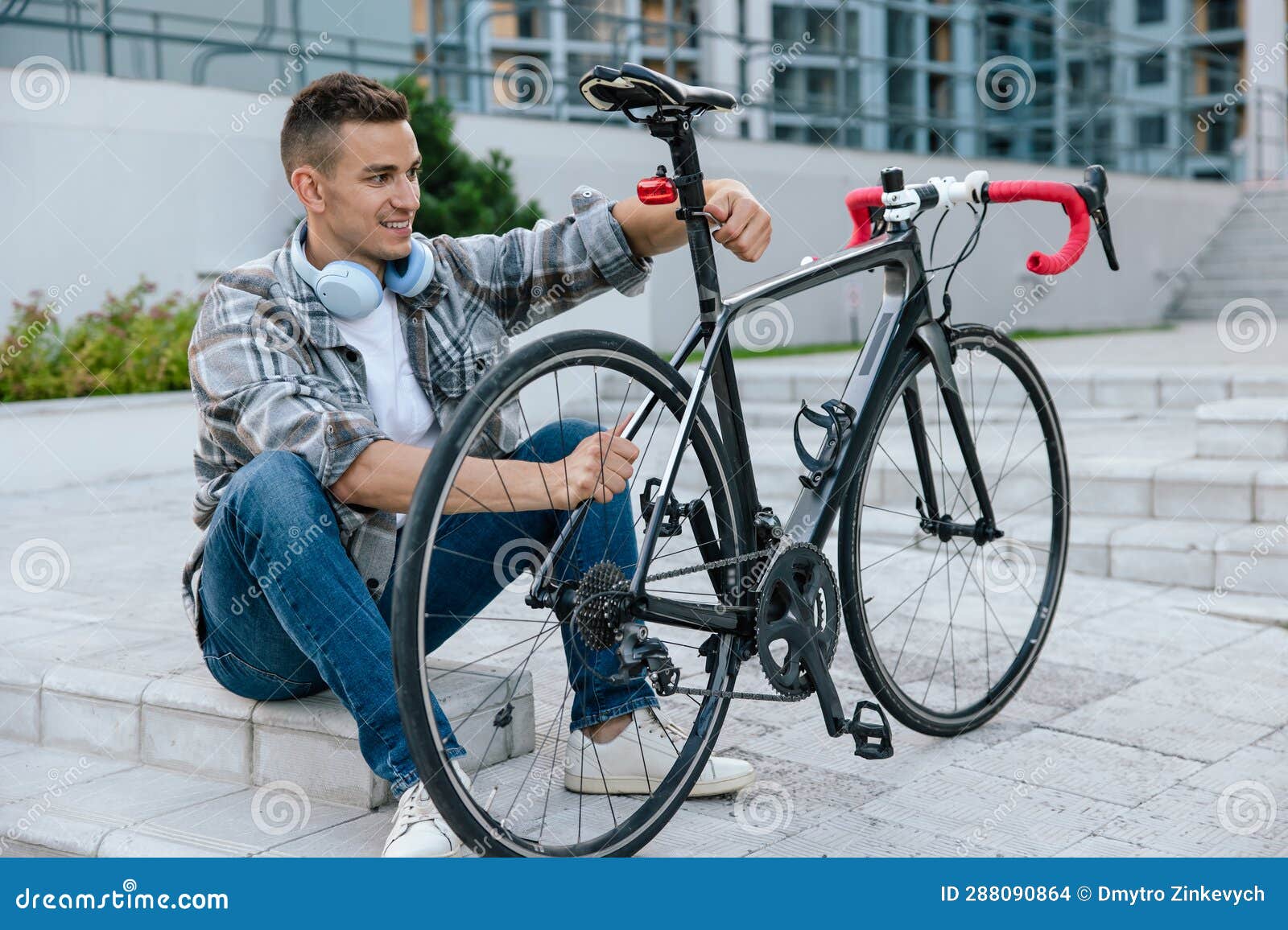 Good-looking Young Man Fixing a Problem with a Bike Tire Stock Photo ...