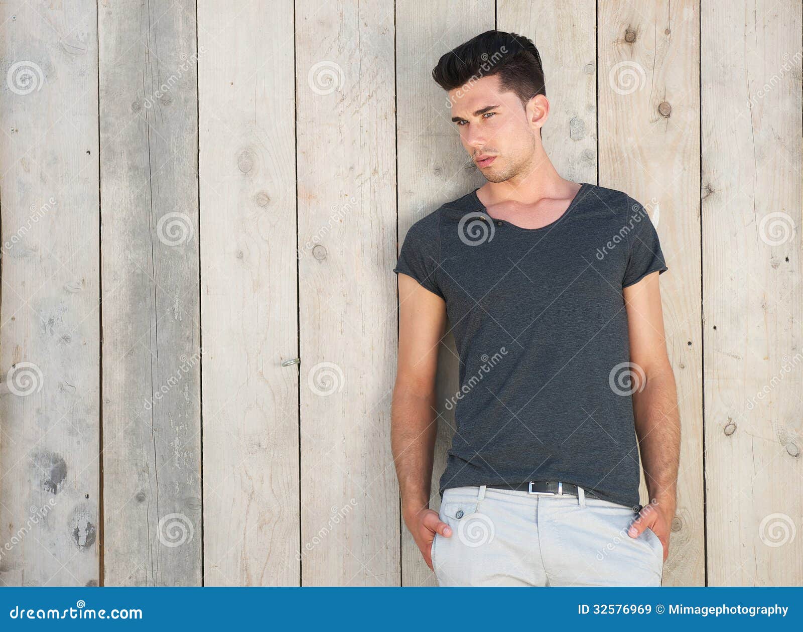 Good Looking Young Man Standing Outdoors Against Wall Stock Image ...