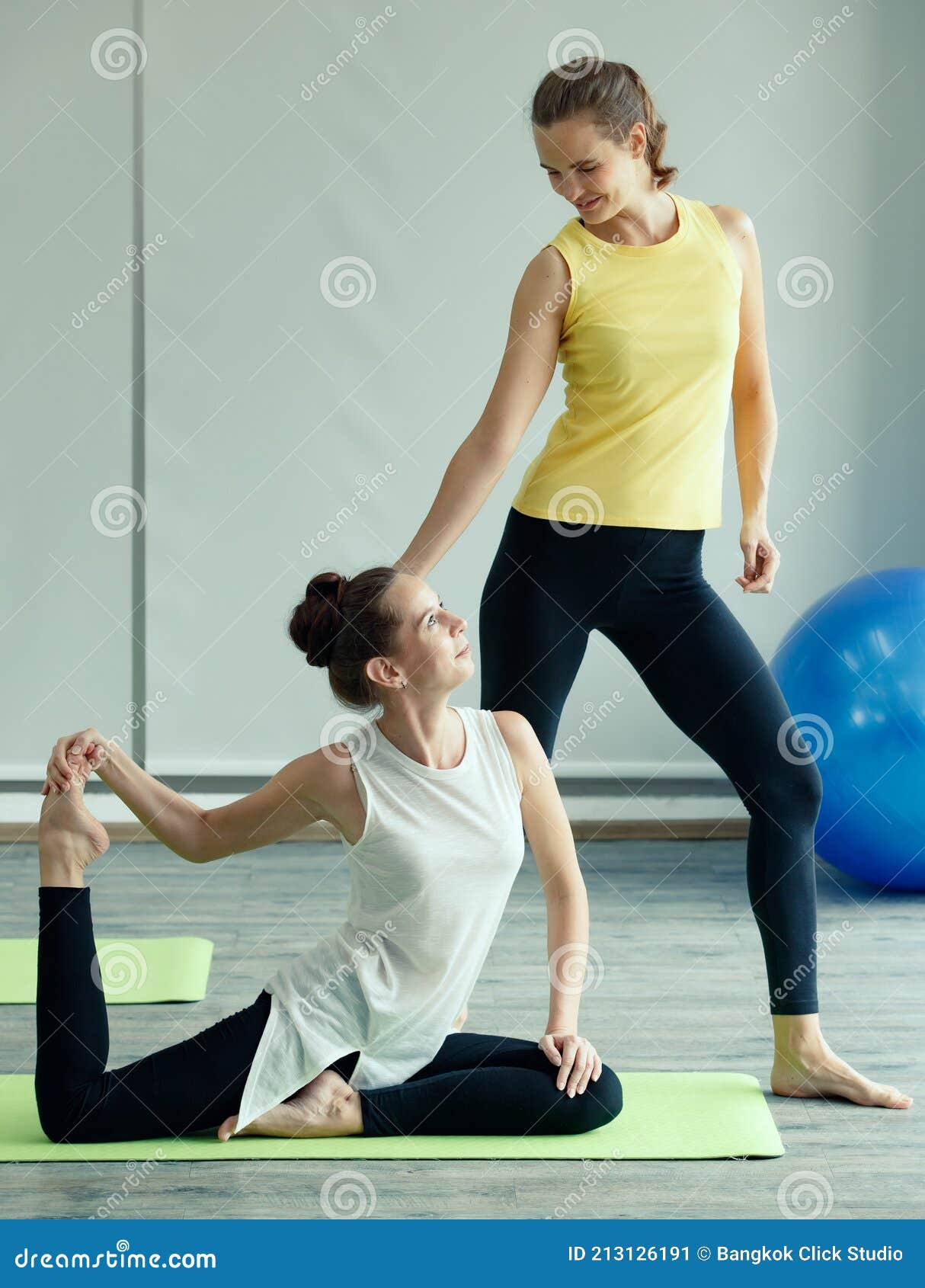 Good Shape Female Yoga Master Helps the Newcomer Student To Practice ...