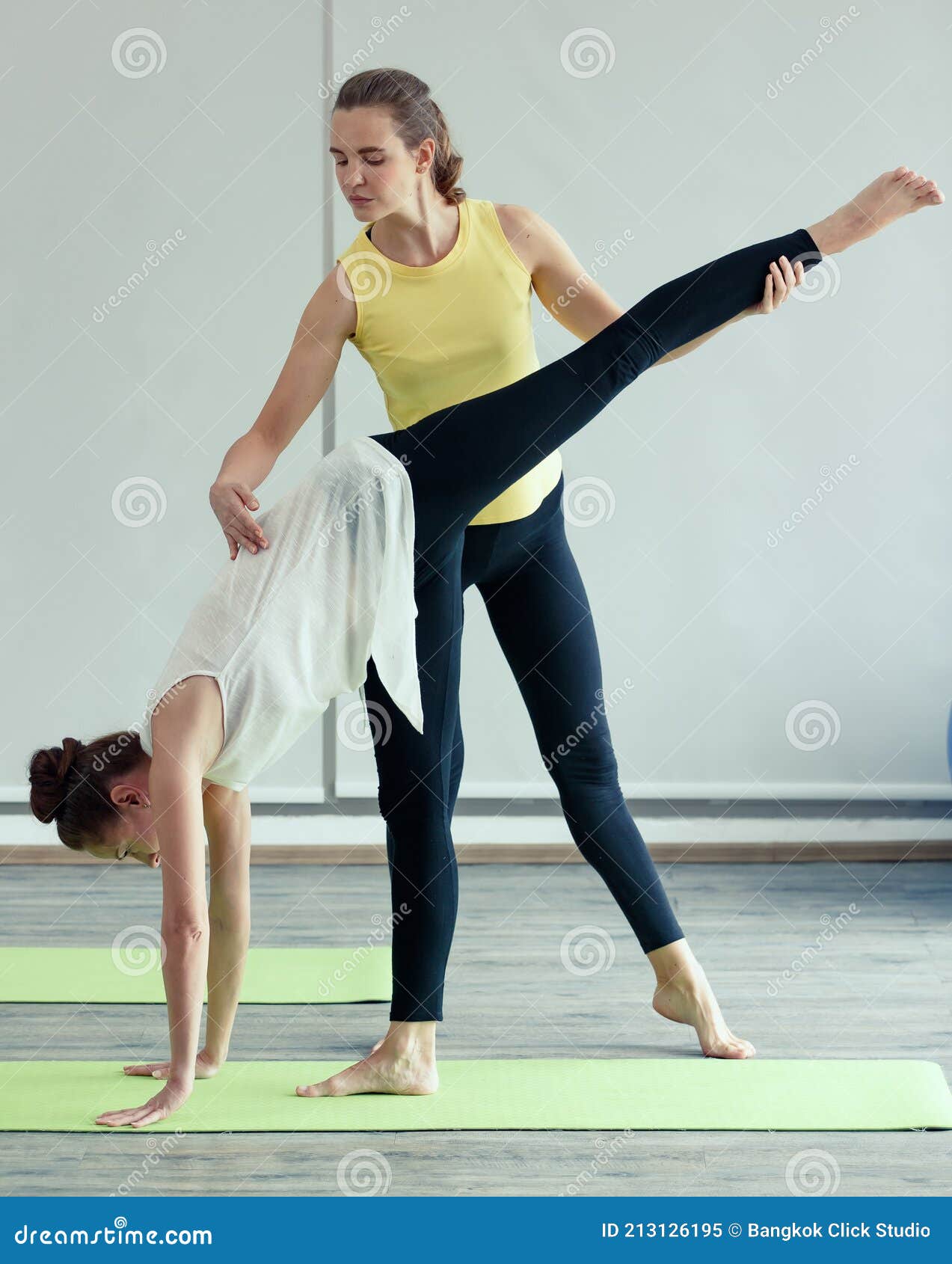 Good Shape Female Yoga Master Helps the Newcomer Student To Practice ...