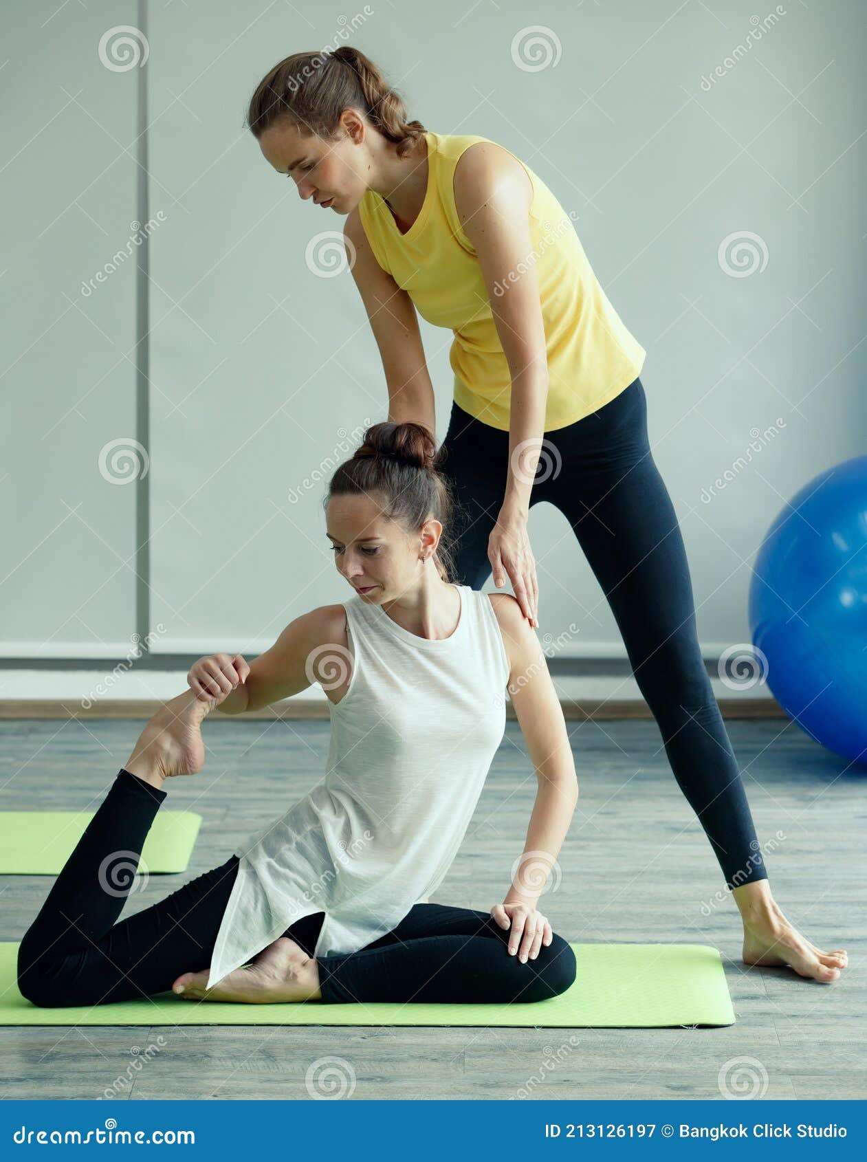 Good Shape Female Yoga Master Helps the Newcomer Student To Practice ...