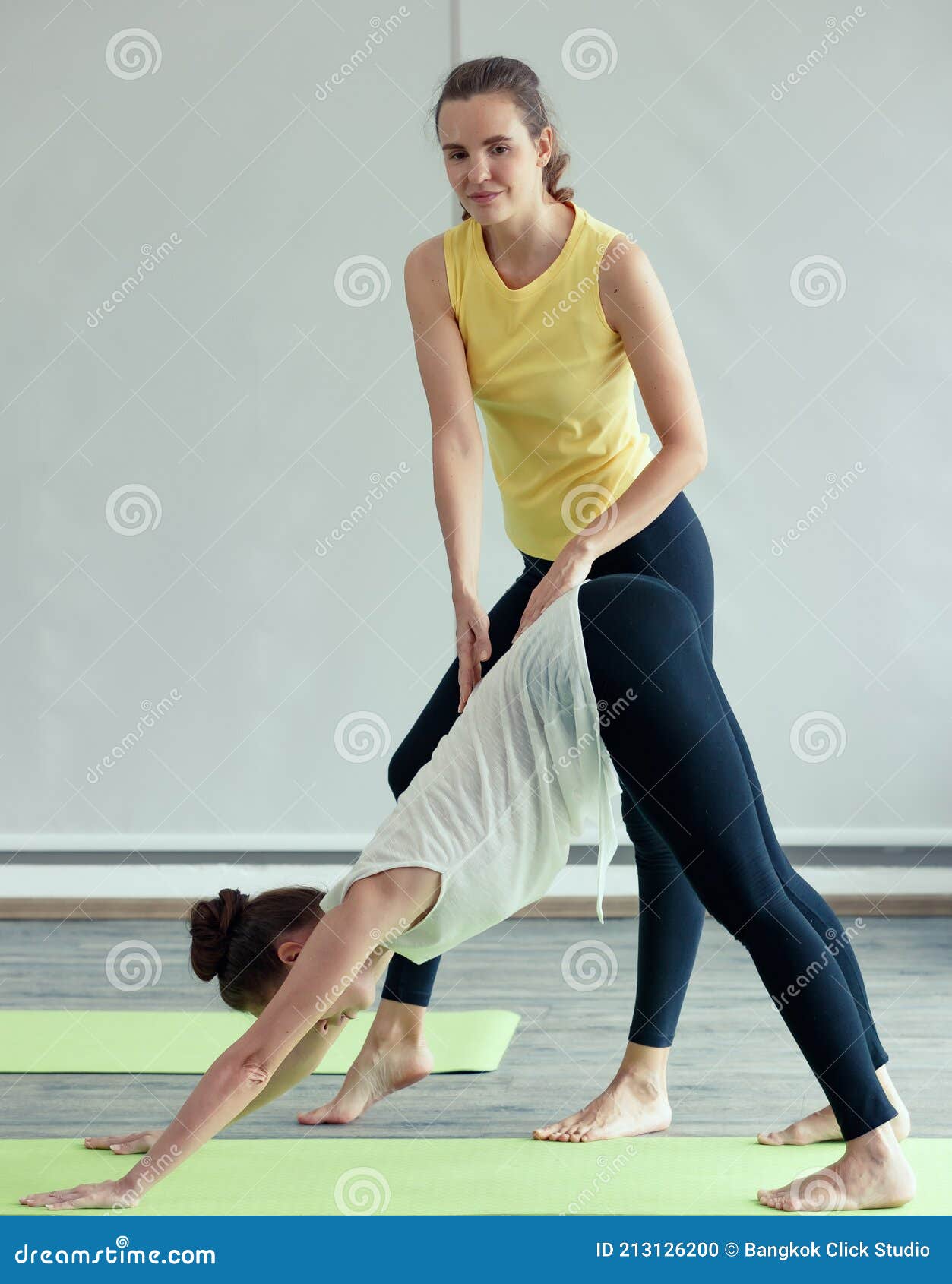 Good Shape Female Yoga Master Helps the Newcomer Student To Practice ...