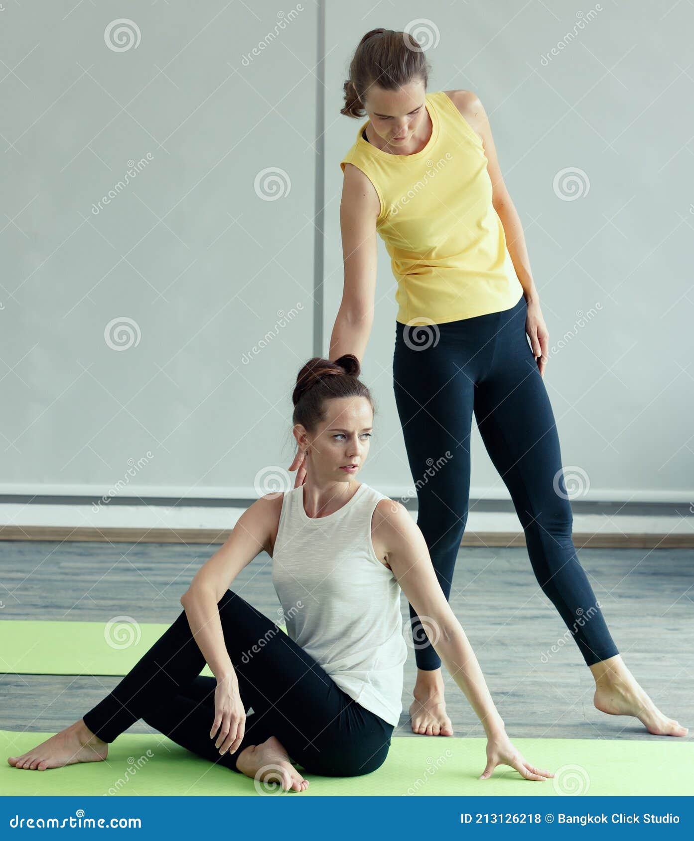 Good Shape Female Yoga Master Helps the Newcomer Student To Practice ...