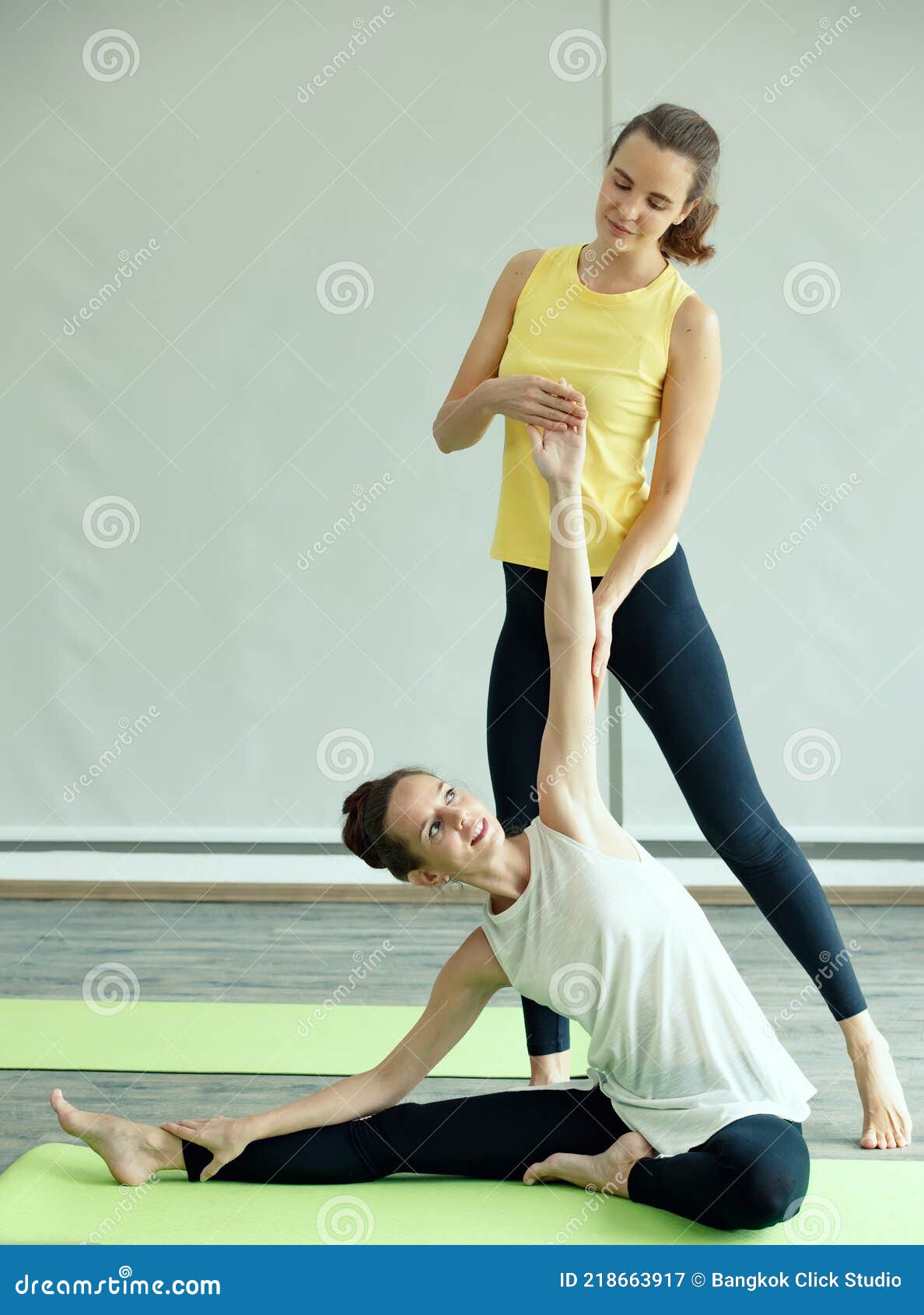 Good Shape Female Yoga Master Helps the Newcomer Student To Practice ...