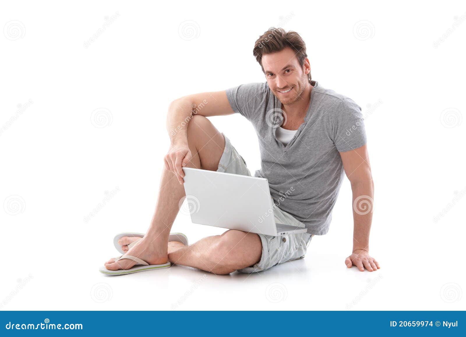 Goodlooking Man Using Laptop Smiling Stock Photo - Image of floor ...