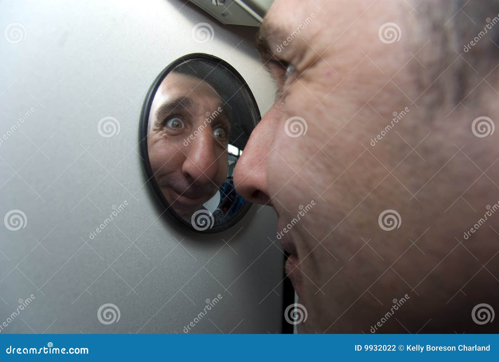 Goofy Man Looks in Round Mirror Stock Photo - Image of looking, smiling ...