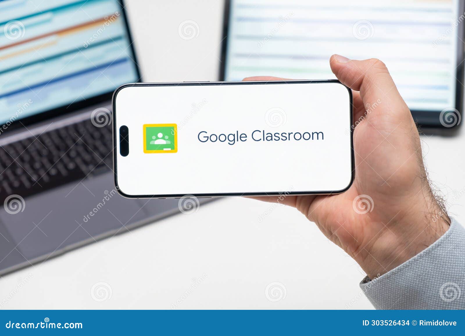 Google Classroom Application Logo on the Screen of Smart Phone in Mans ...