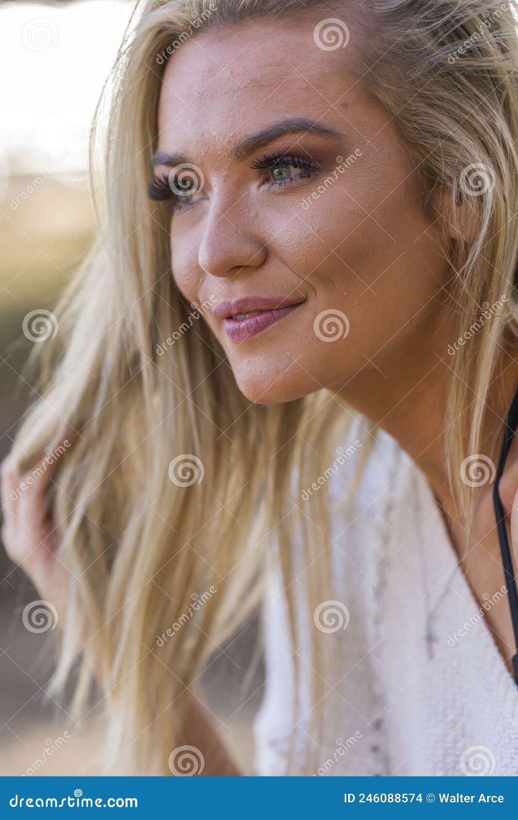 A Lovely Blonde Bikini Model Poses Outdoors Near A Lake While Enjoying The Summer Weather Stock