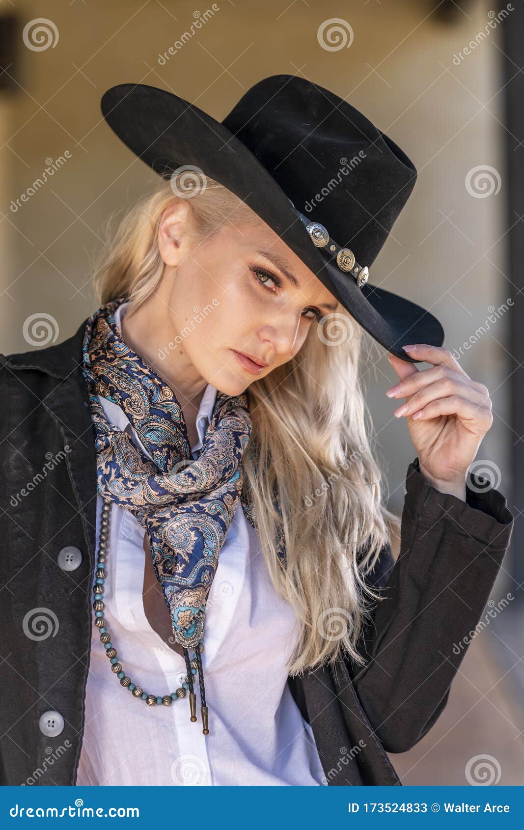 A Lovely Blonde Model Dressed As A Cowgirl Enjoys The American West