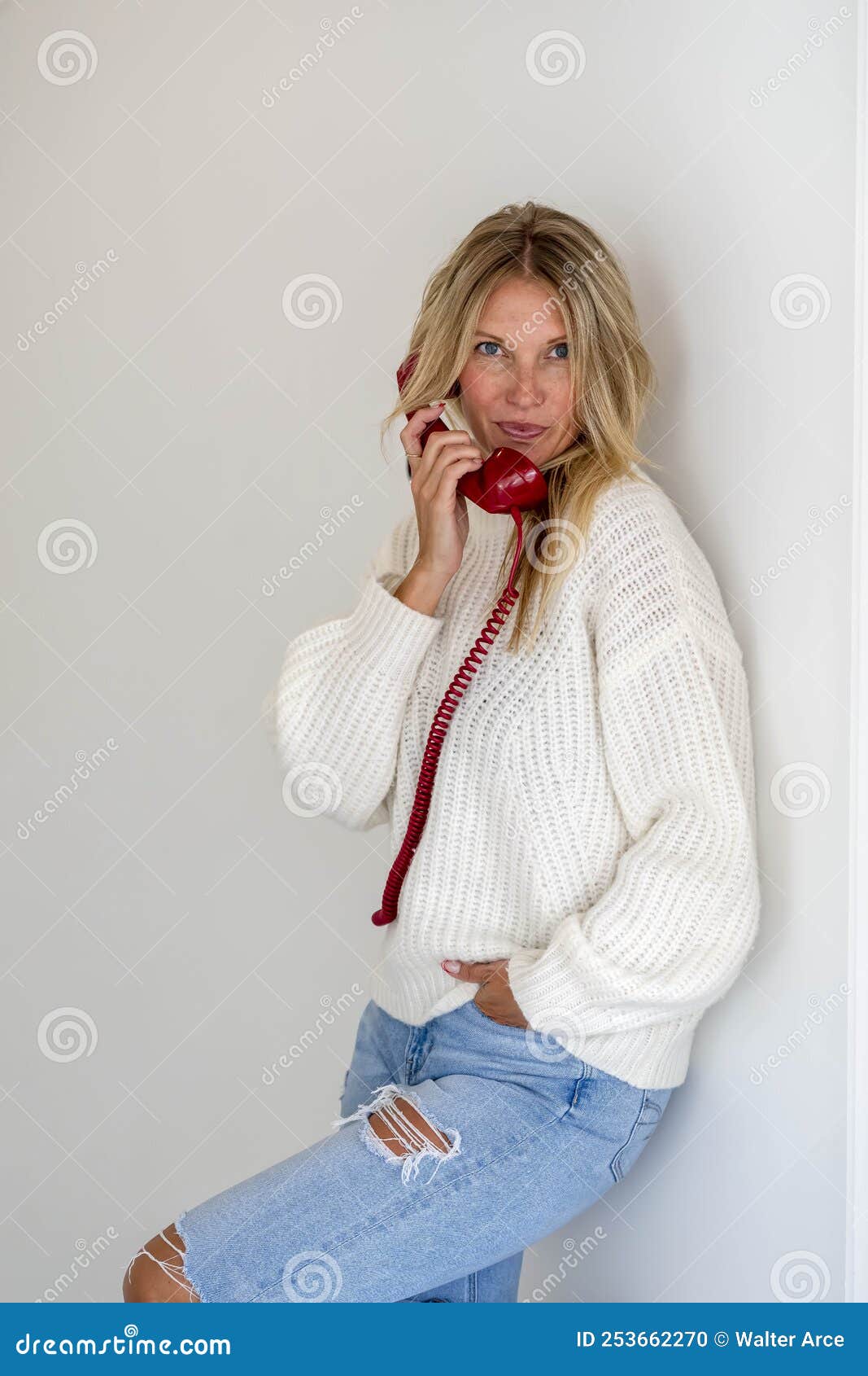 A Gorgeous Blonde Model Talks on the Phone Showing Emotion in a Home ...