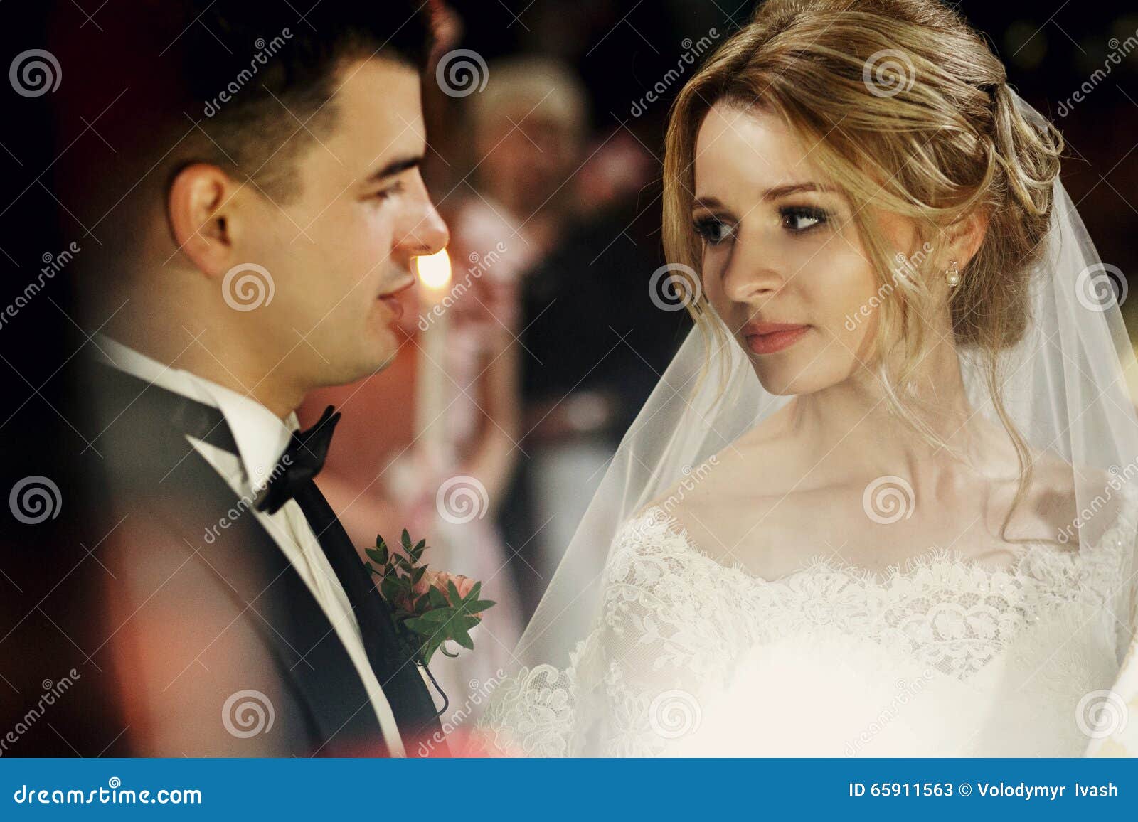 Gorgeous Emotional Blonde Bride Looking At Handsome Young Groom Stock
