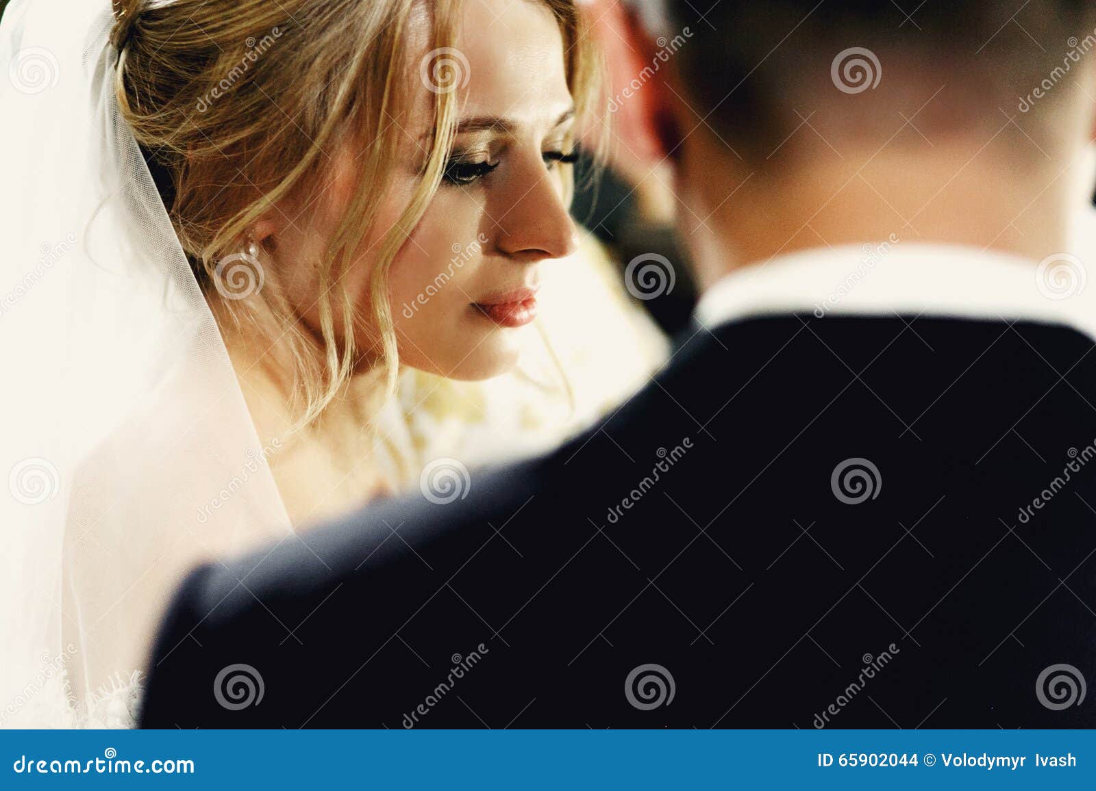 Gorgeous Emotional Blonde Bride Looking At Handsome Young Groom Stock