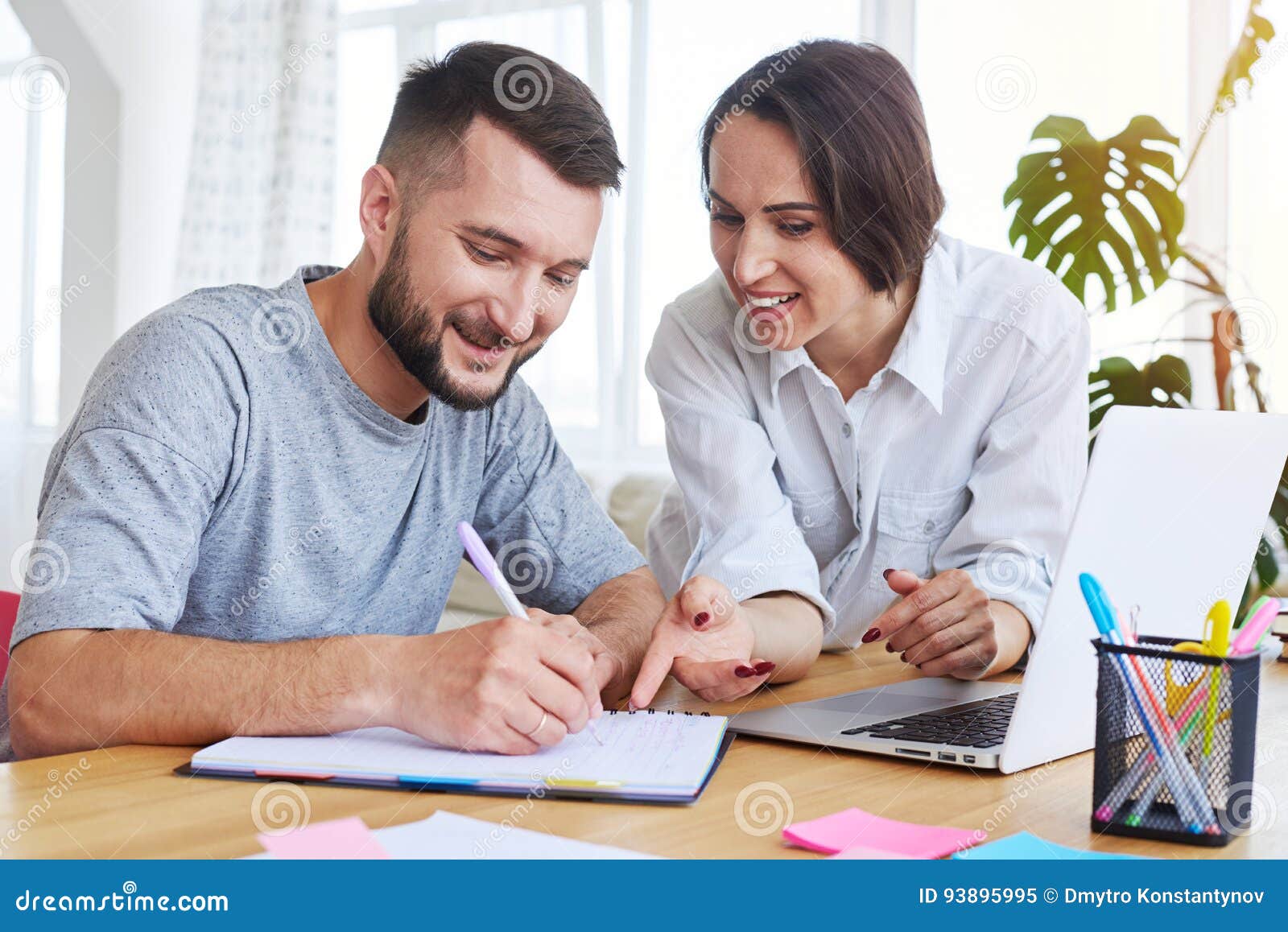 Gorgeous Lady Telling Something while Man Writing in Notebook Stock ...