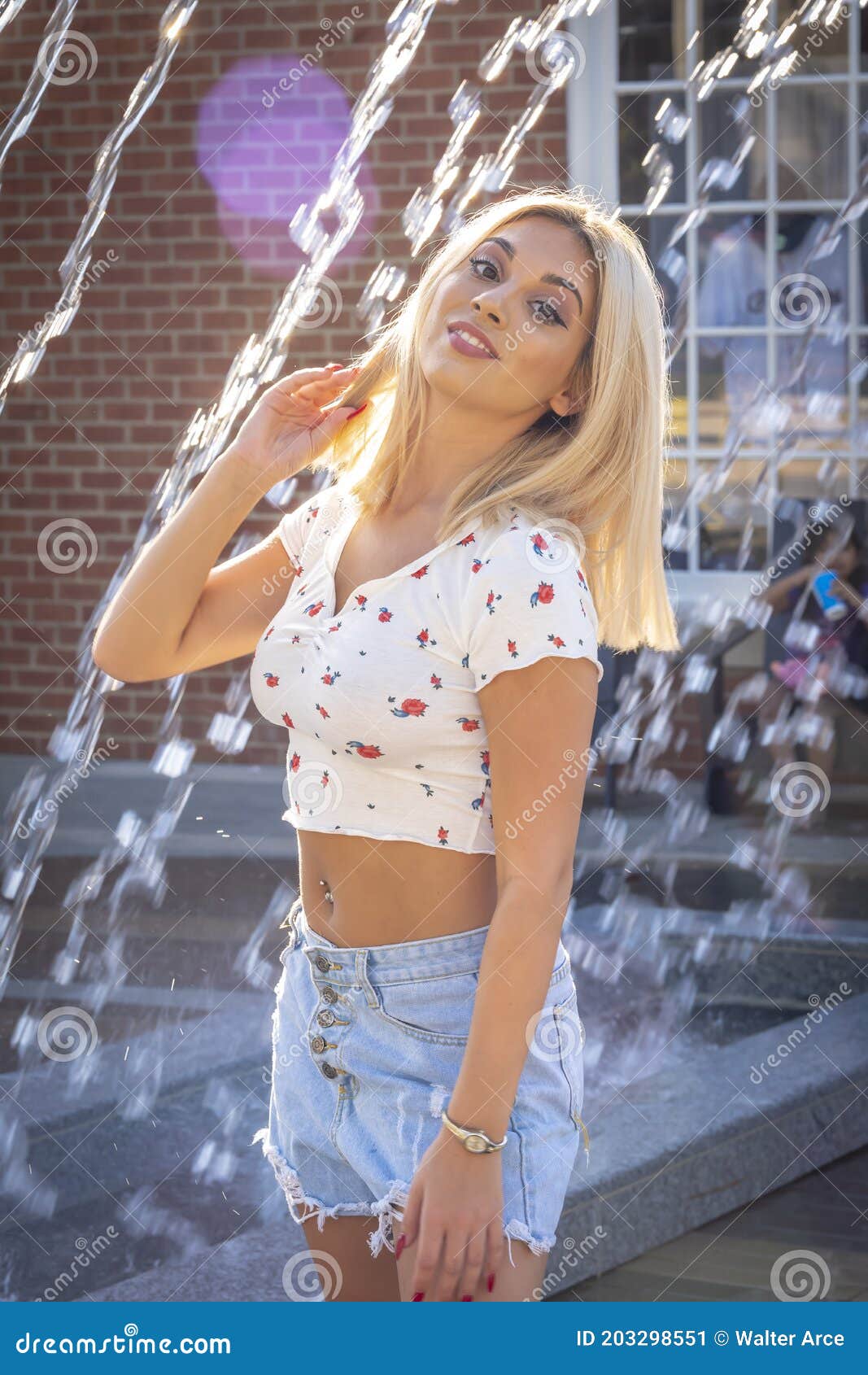 A Young Lovely Blonde Model Poses Outdoors While Enjoying A Summers Day