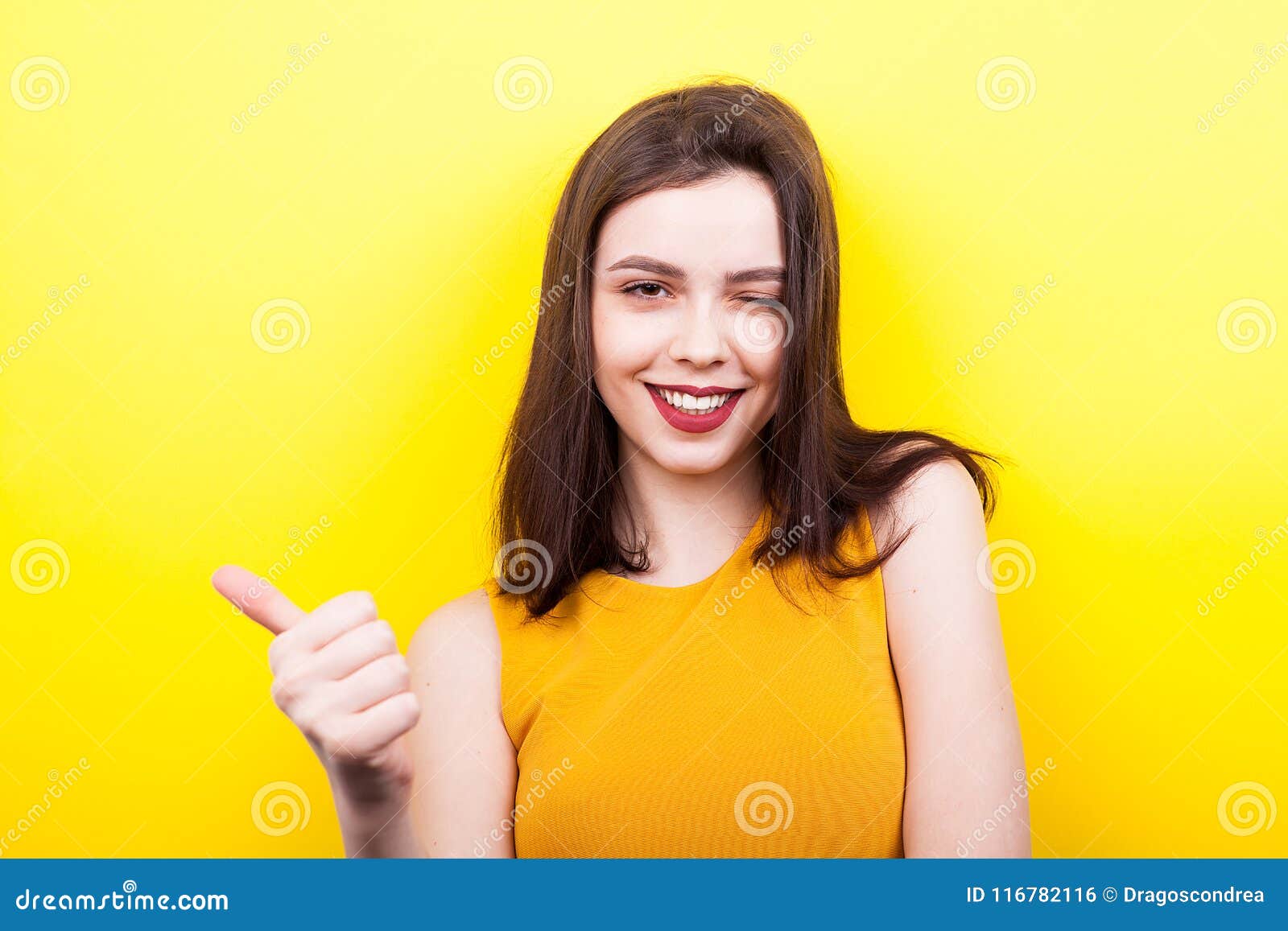 Gorgeous Young Woman Giving a Thumbs Up and Winking Stock Photo - Image ... Gorgeous Young Woman Giving a Thumbs Up and Winking Stock Photo - Image ...