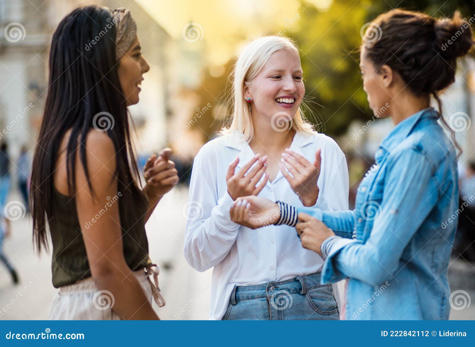Three Women Standing on Street and Talking Gossip Stock Photo - Image ...