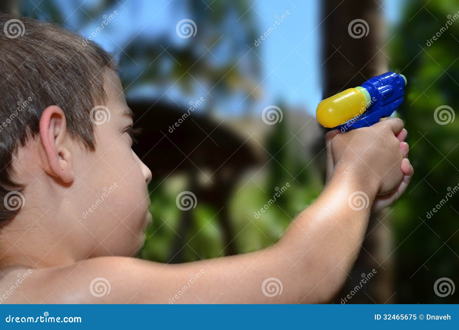 Gotcha! a Young Boy Serious about His Water Toy Gun Stock Image - Image ...