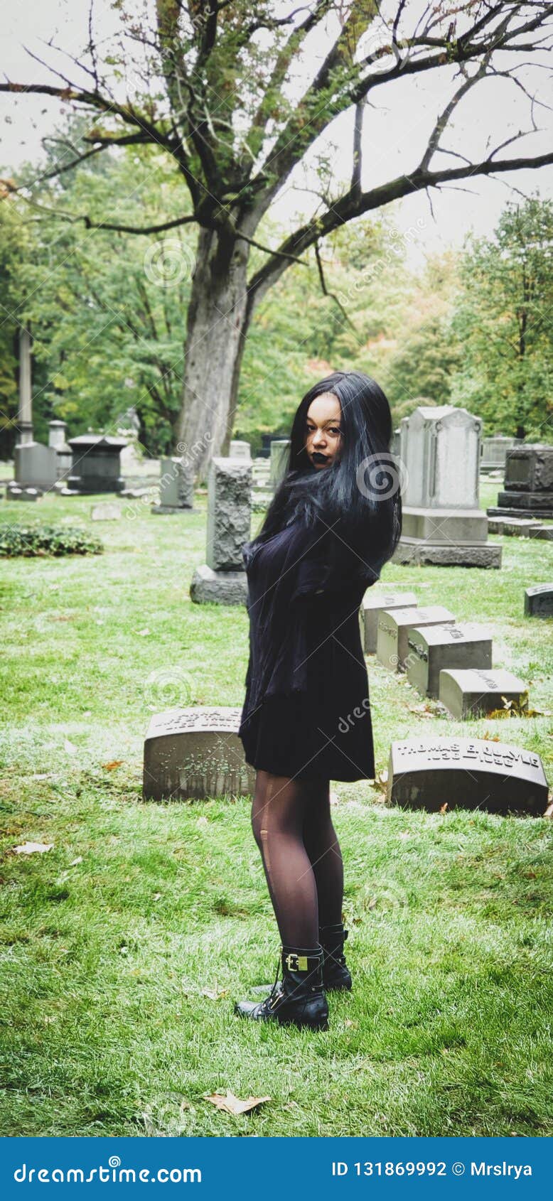 Portrait of a Girl Dressed in All Black Standing in a Cemetary Stock ...