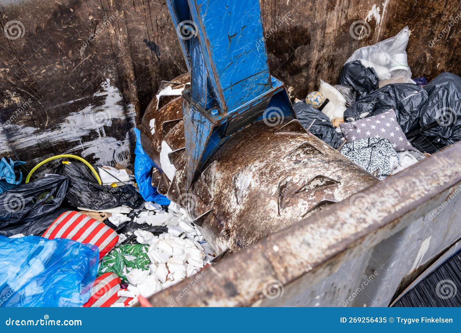 Roller of a Trash Compactor Compressing Refuse in a Container ...