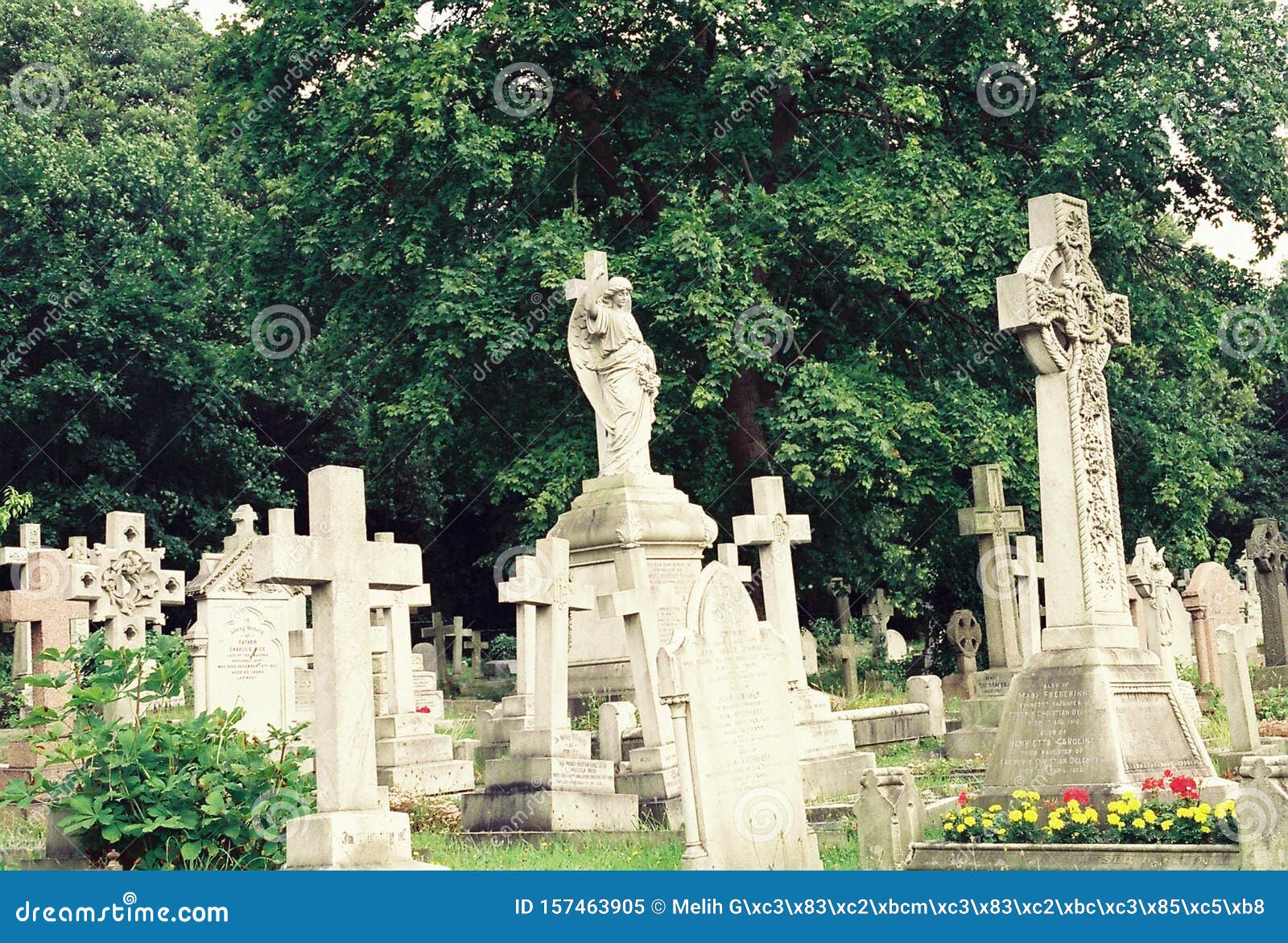 Statues, Crosses, And Tombstones In A Cemetery Stock Photography ...