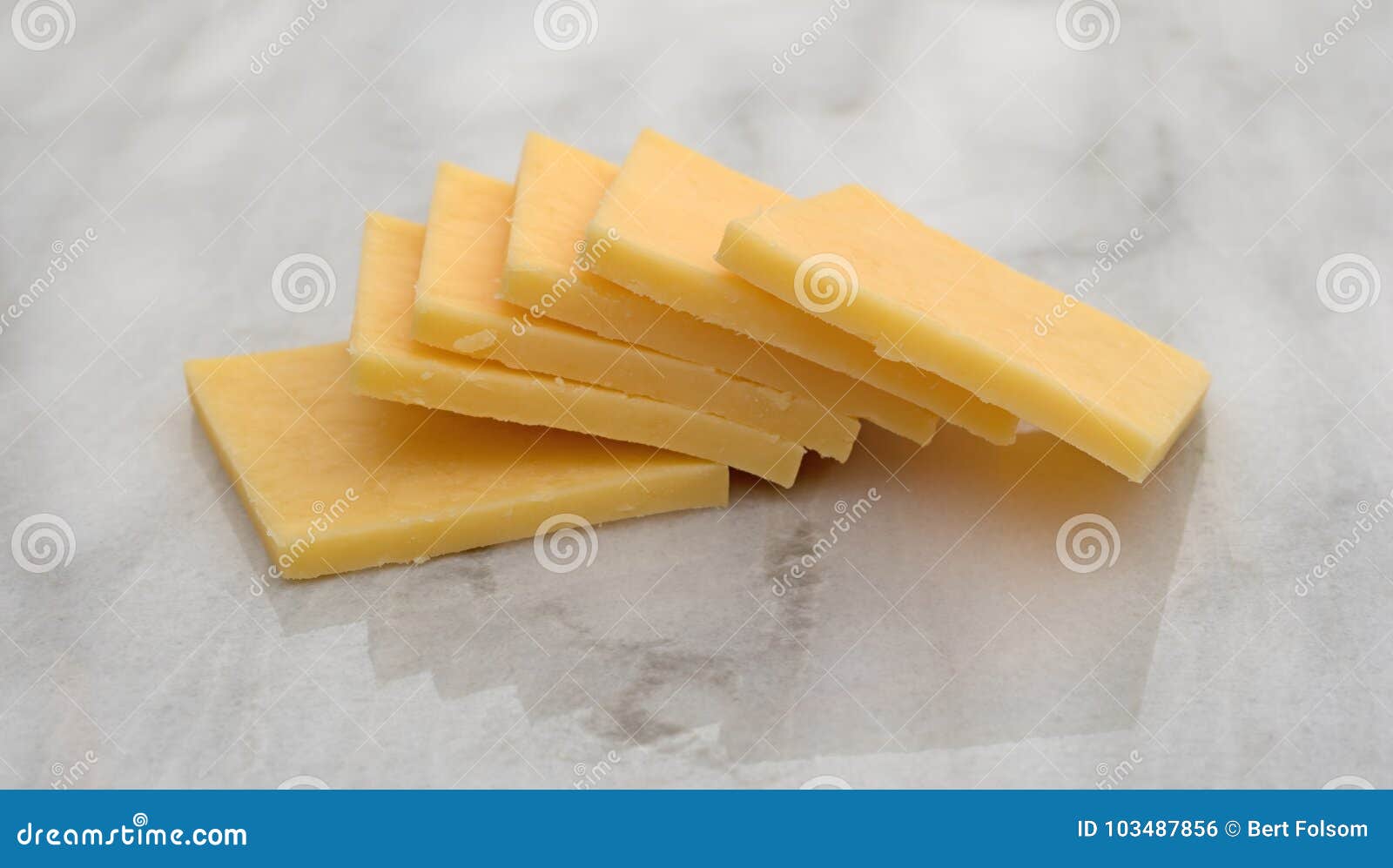 Gouda Cheese Slices on a Cutting Board Stock Photo - Image of marble ...
