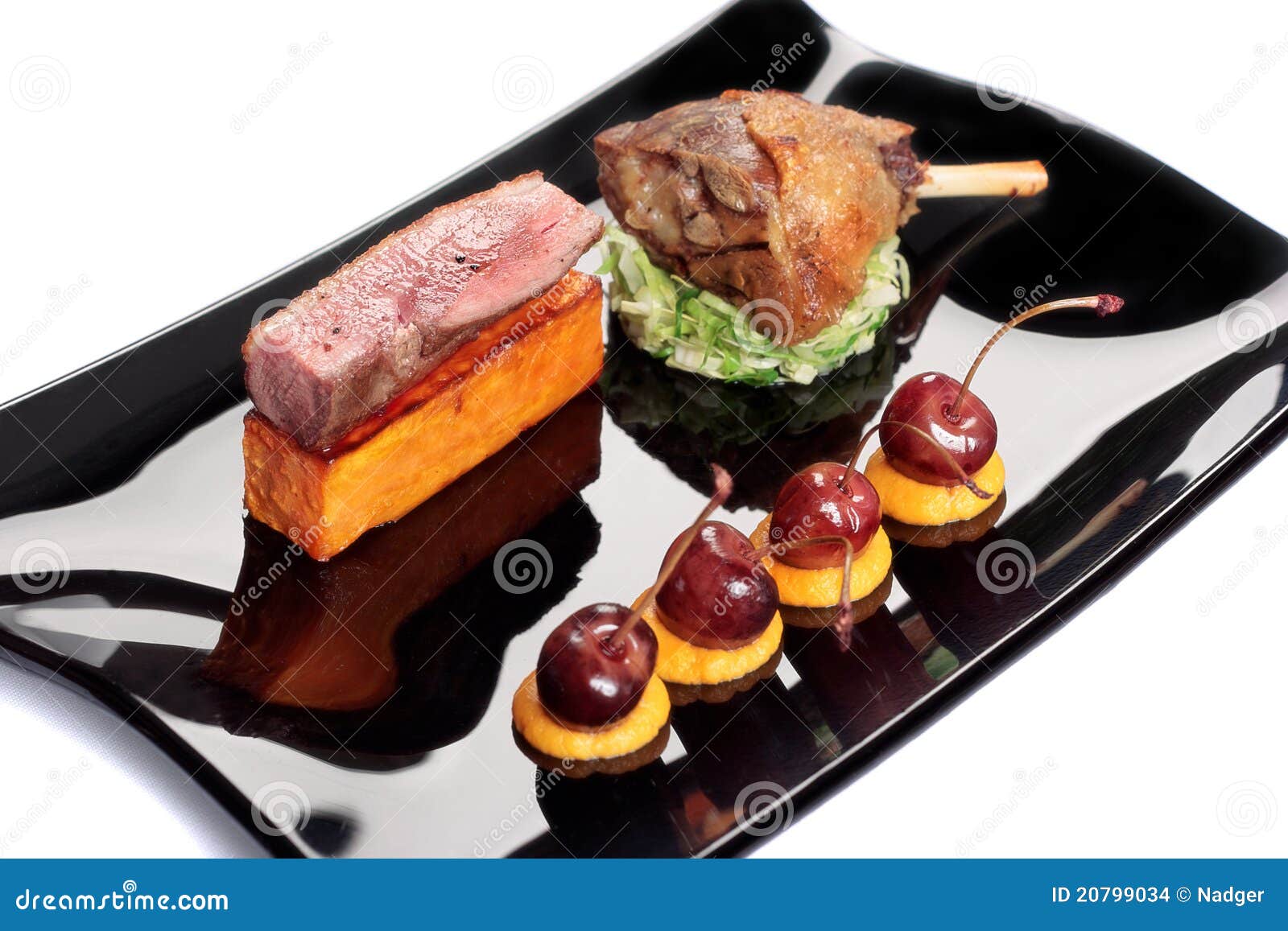 Gourmet Dish on a Black Plate Stock Photo - Image of plate, cherries ...