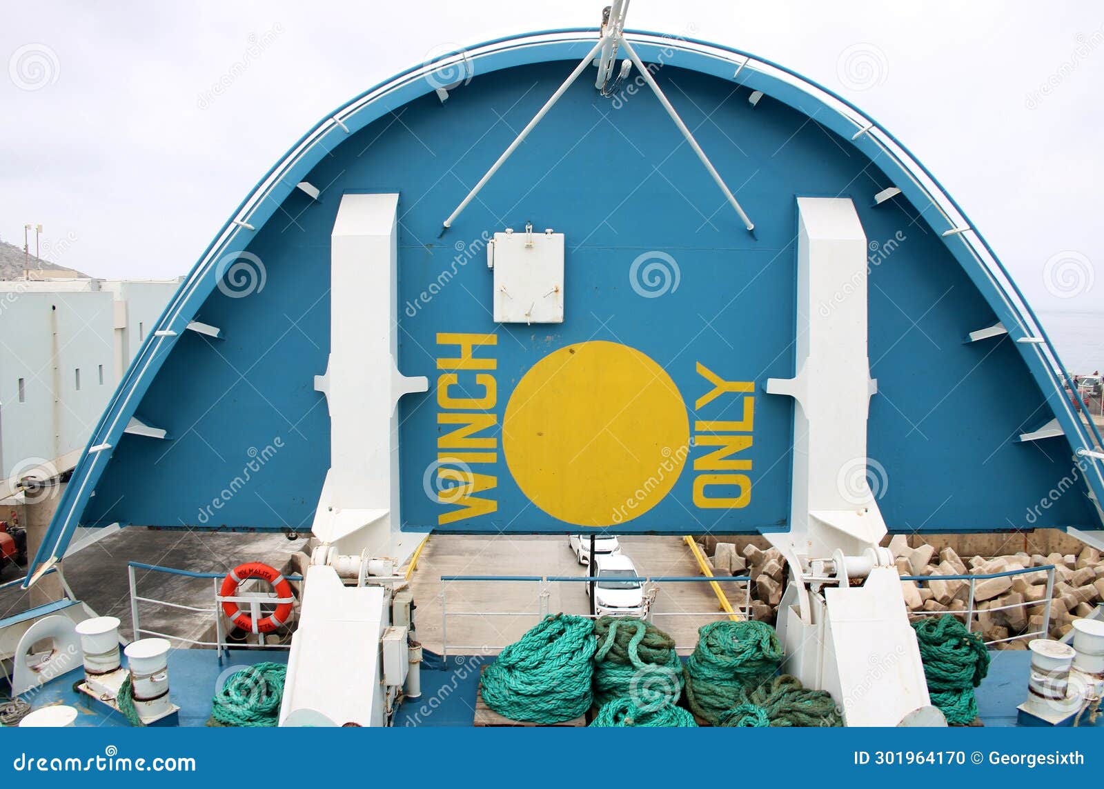 Winch Of A Ferry Ship. A Sailor Maneuvering The Mooring Rope To ...