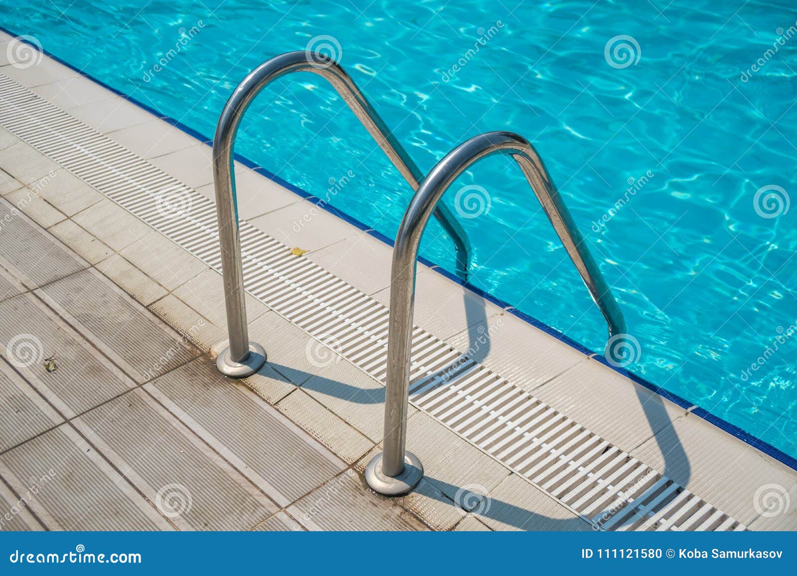 Grab Bars Ladder in the Blue Swimming Pool Stock Photo - Image of ...