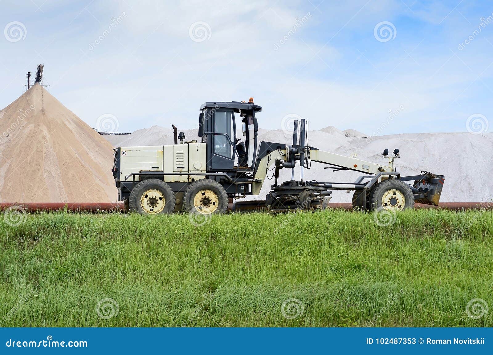 The Grader is at the Dam with Pipeline in the Background of Mine. Side ...
